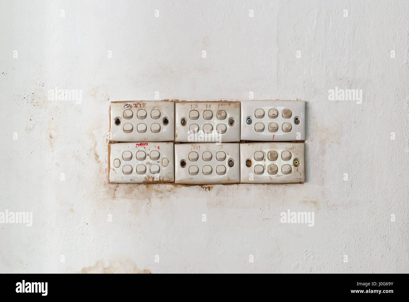Row of Dirty Light Switches on Stained Concrete Wall Stock Photo - Alamy
