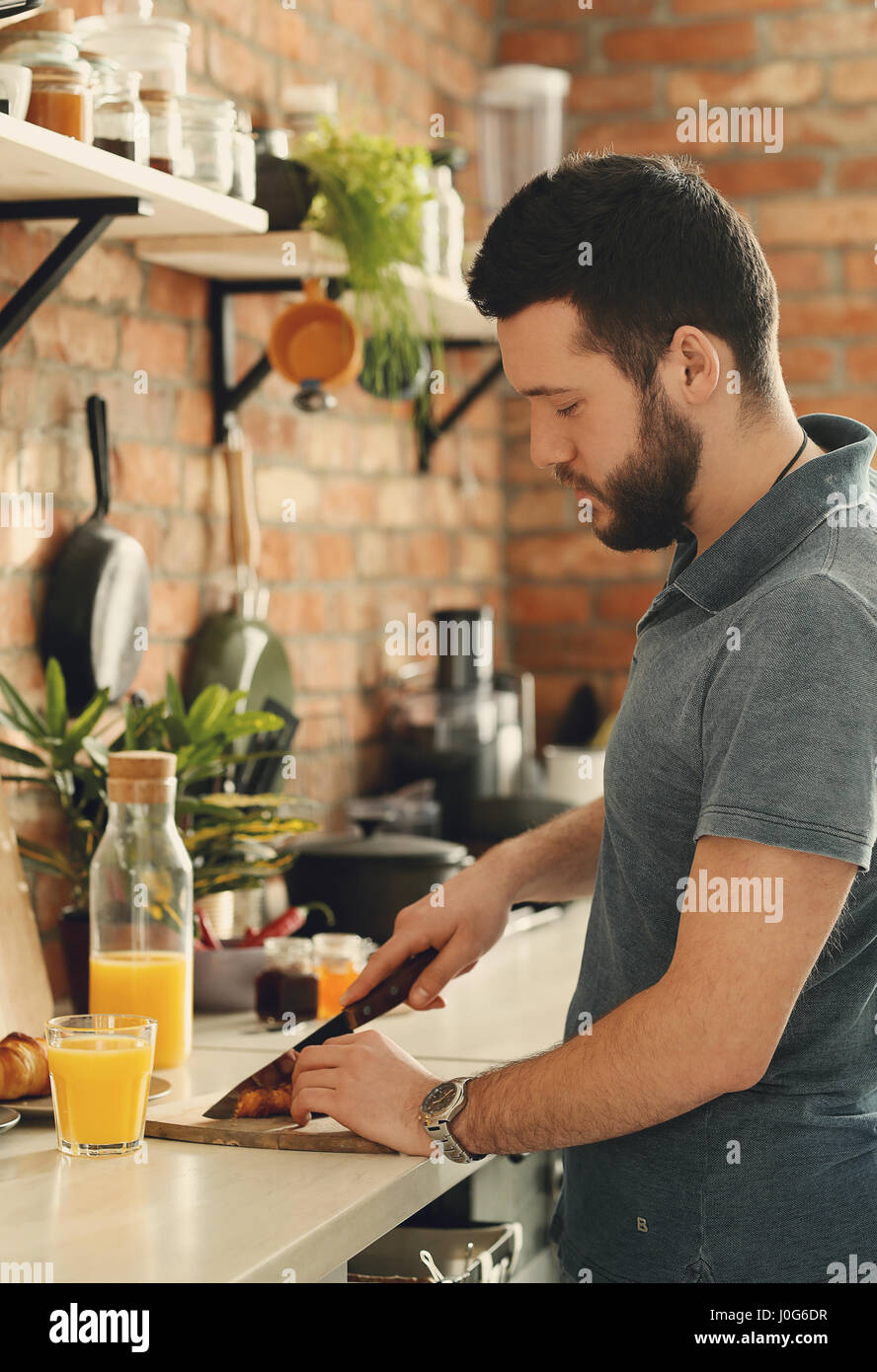 Cooking. Handsome man at kitchen Stock Photo - Alamy