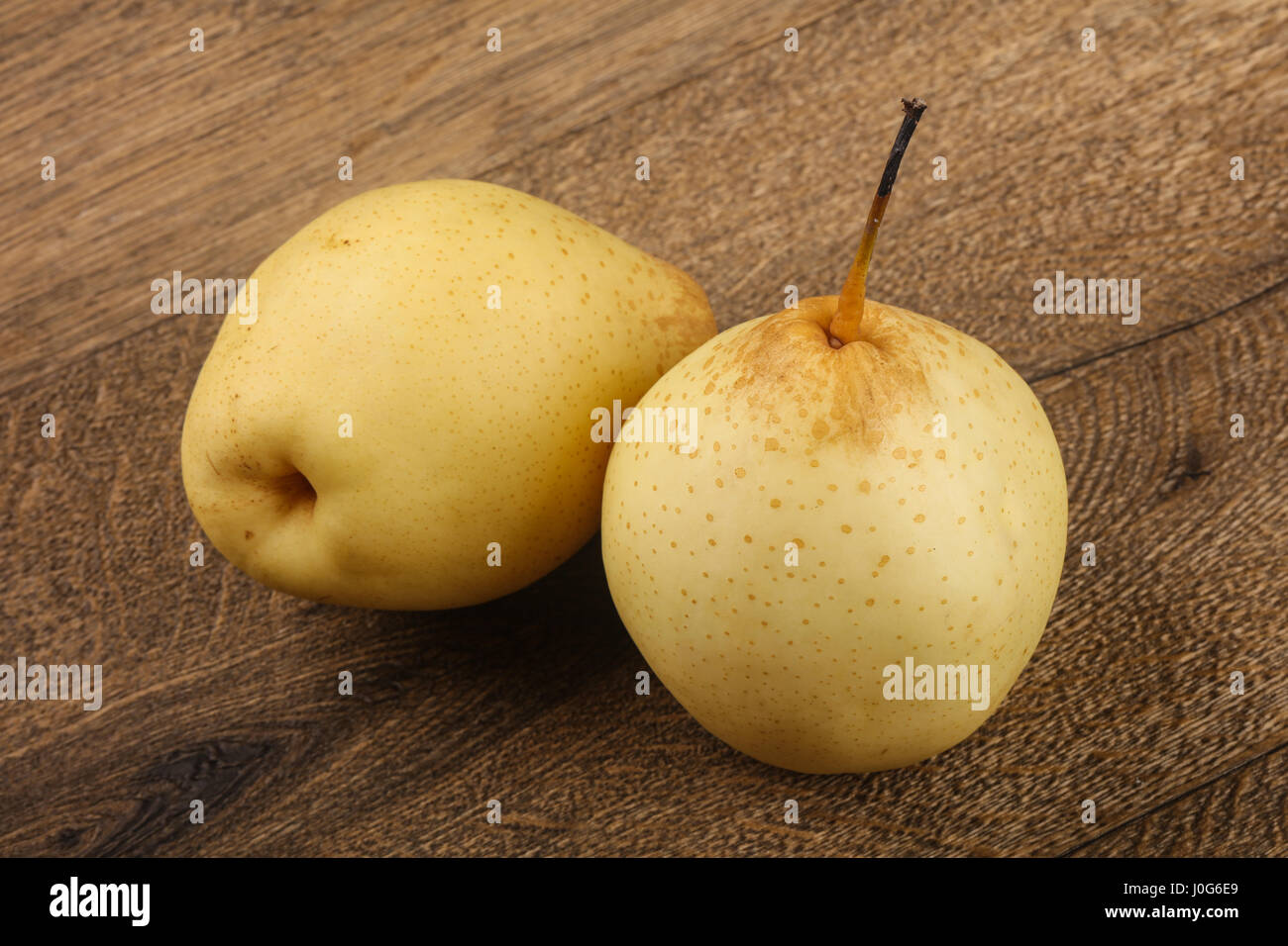 Sweet Chinese pear over the wooden background Stock Photo - Alamy
