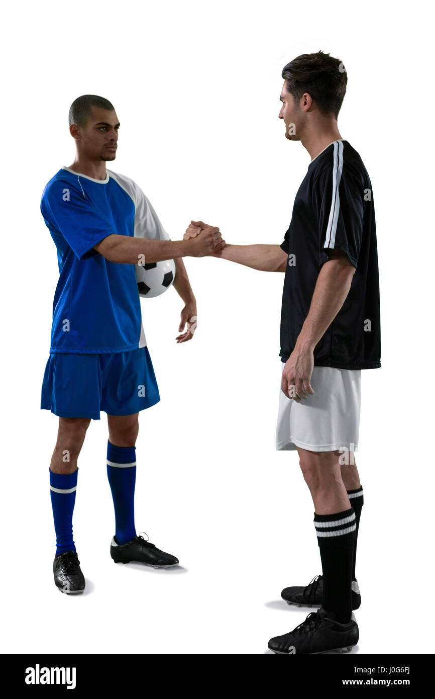 Two football players shaking hands against white background Stock Photo ...