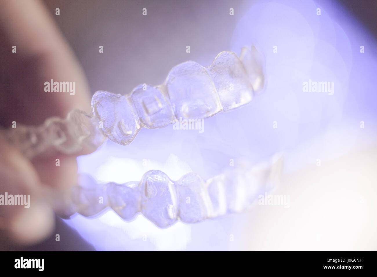 Invisible dental orthodontics on colored background Stock Photo - Alamy