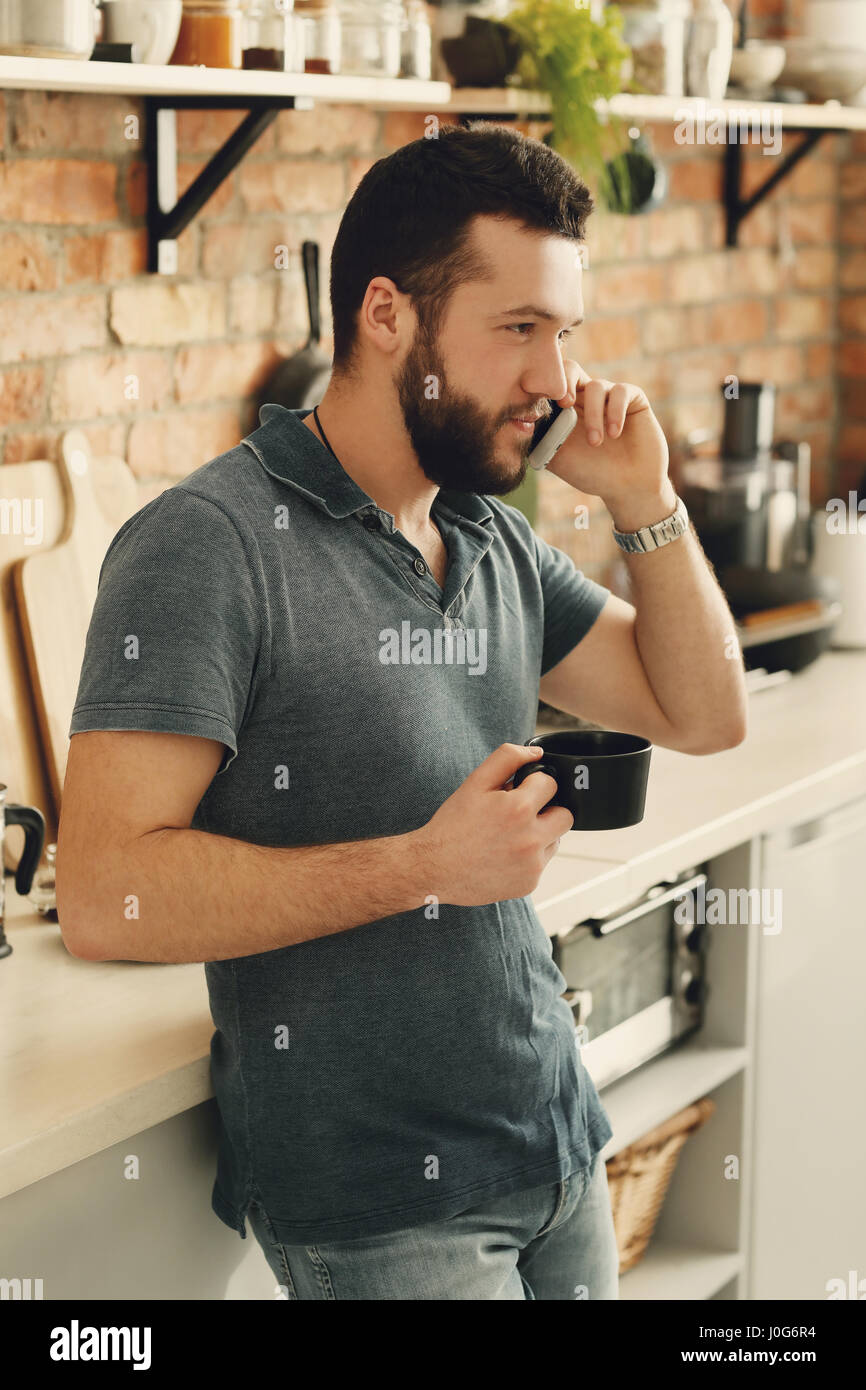 Cooking. Handsome man at kitchen Stock Photo - Alamy