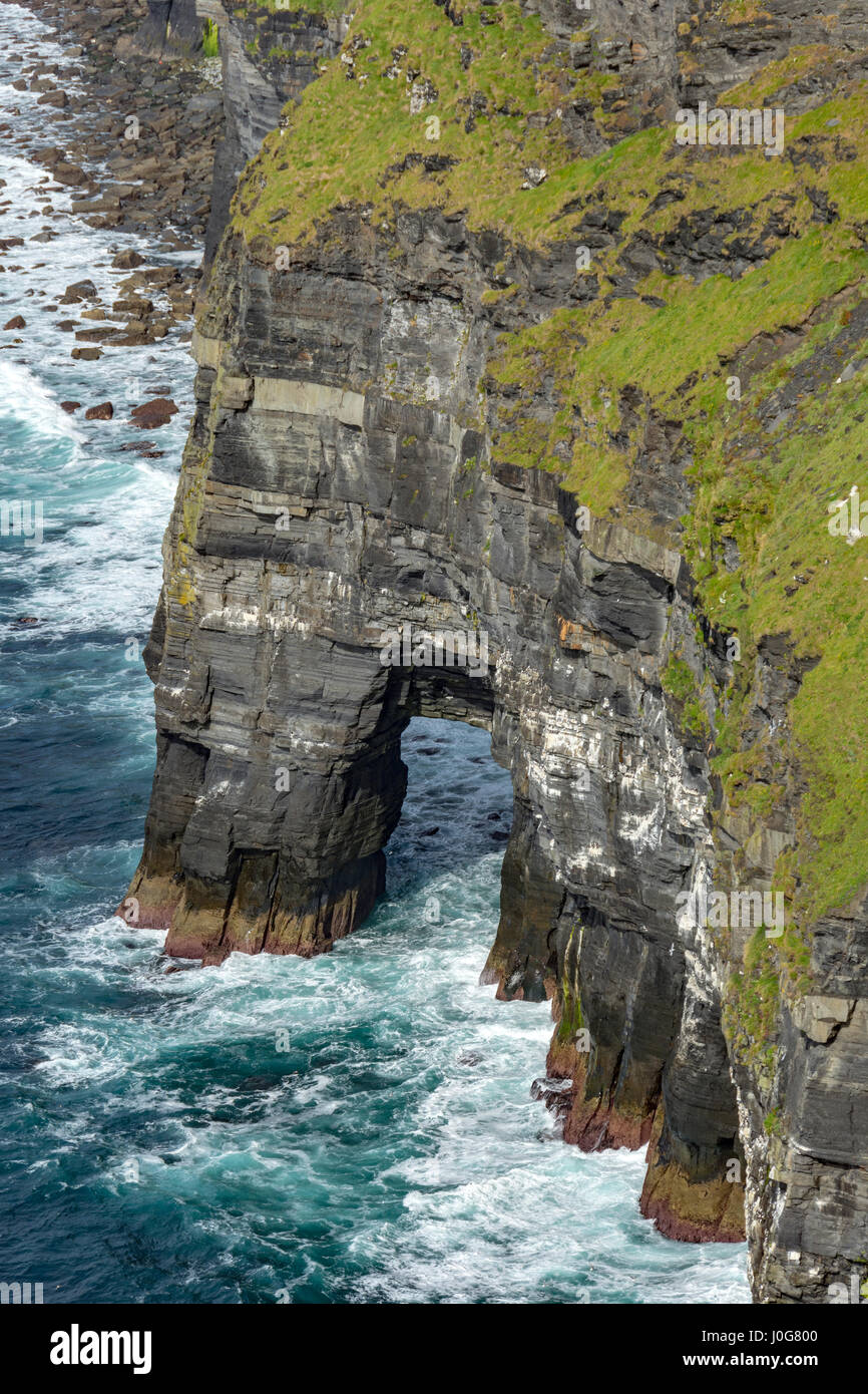 Rock arch at the foot of the Cliffs of Moher, County Clare, Ireland ...