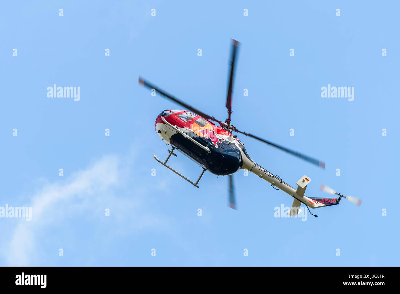 Red helicopter in the air front view, facing towards viewer on plain ...