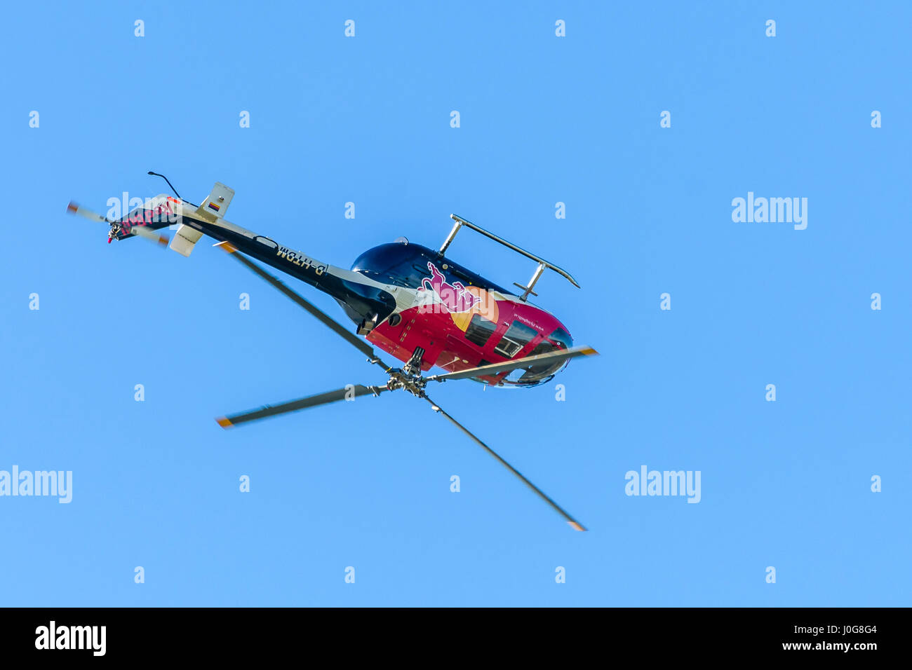 Red helicopter in the air front view, facing towards viewer on plain ...