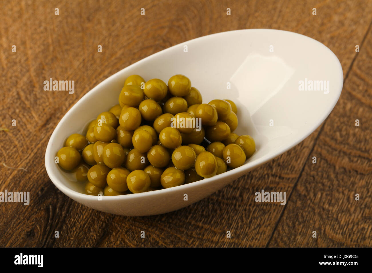 Pickled green pea on the wood background Stock Photo - Alamy