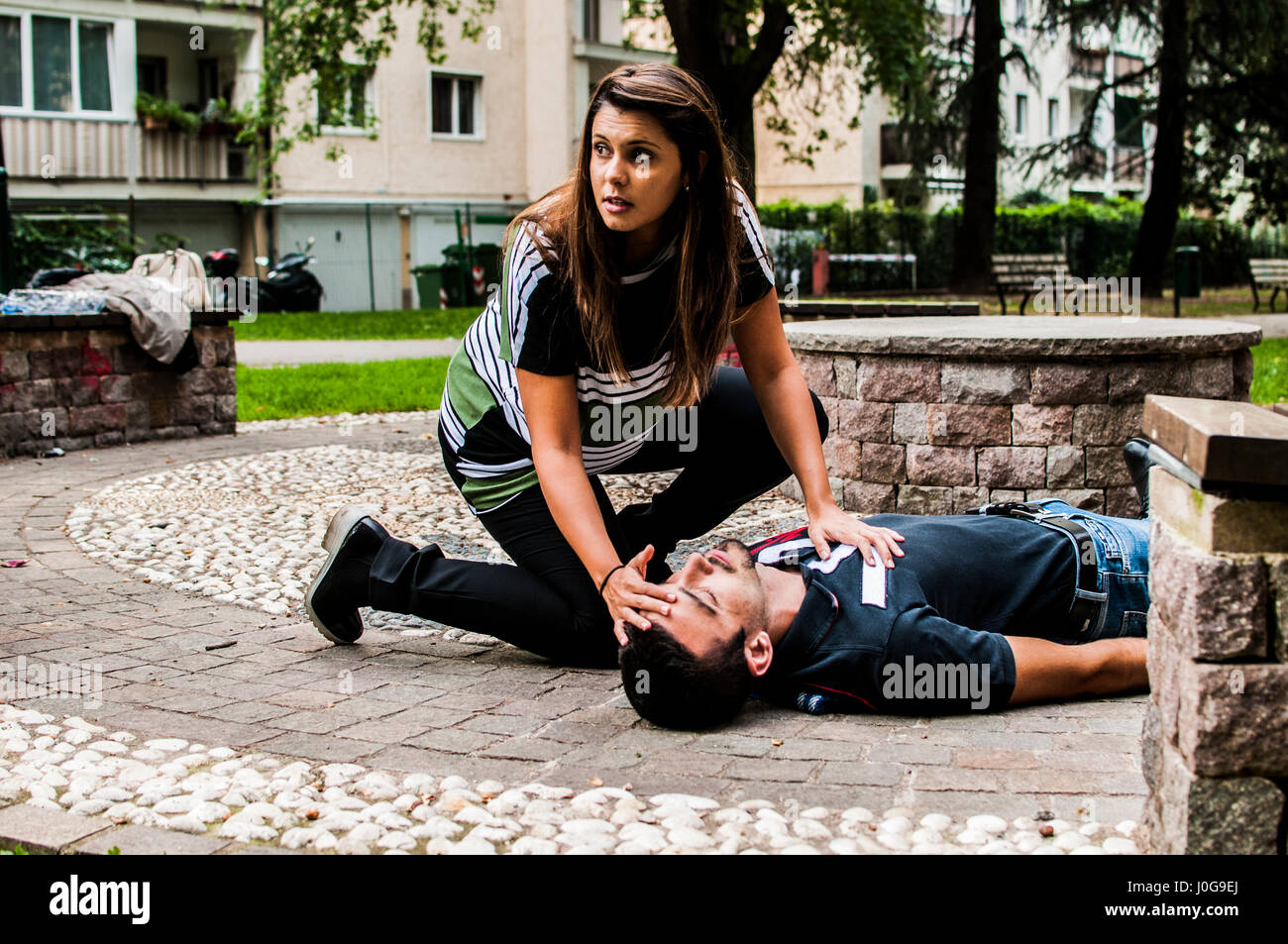 young girl helping a guy after heart attack with cardiopulmonary ...