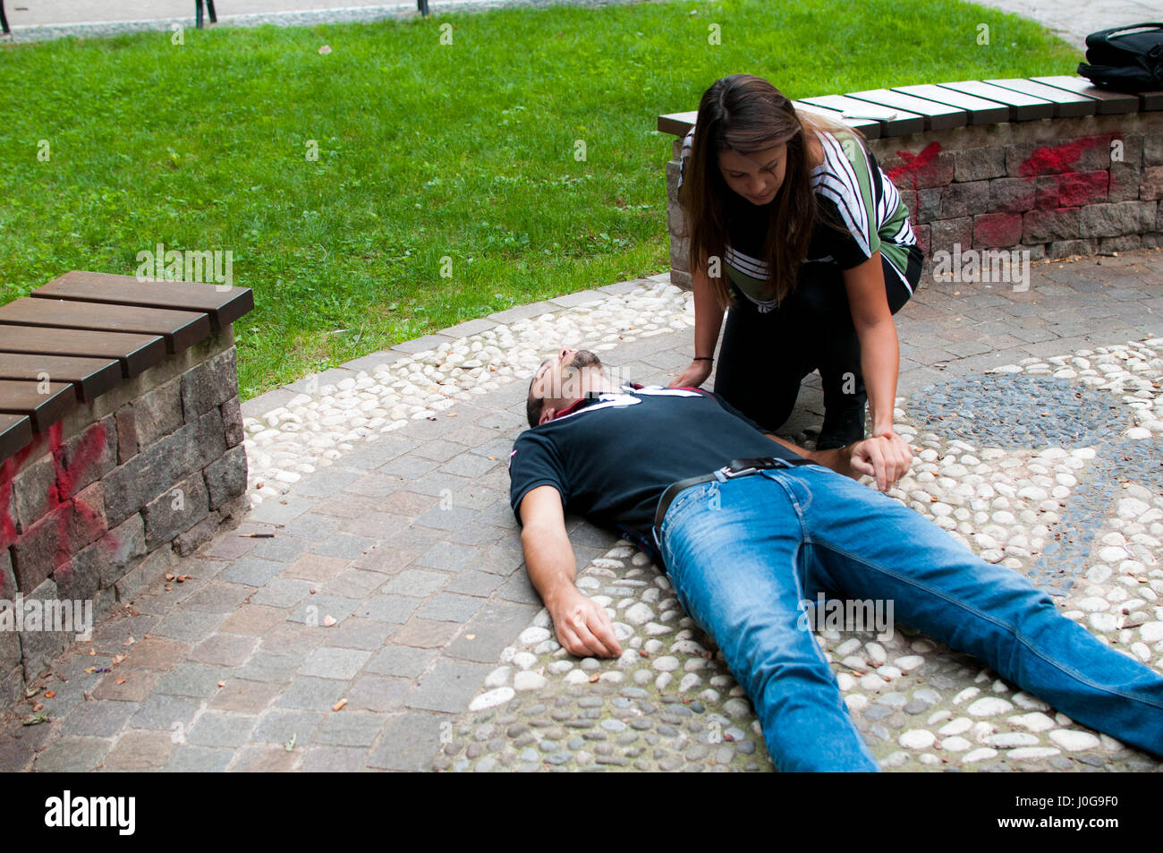 young girl helping a guy after heart attack with cardiopulmonary ...