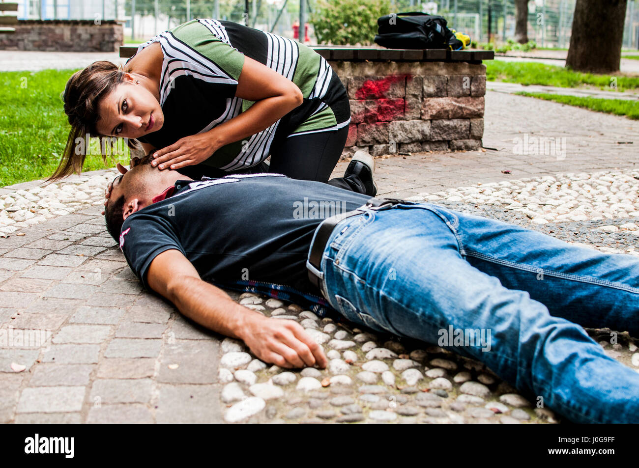 young girl helping a guy after heart attack with cardiopulmonary ...