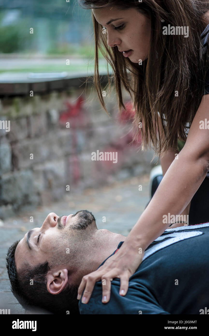 young girl helping a guy after heart attack with cardiopulmonary ...