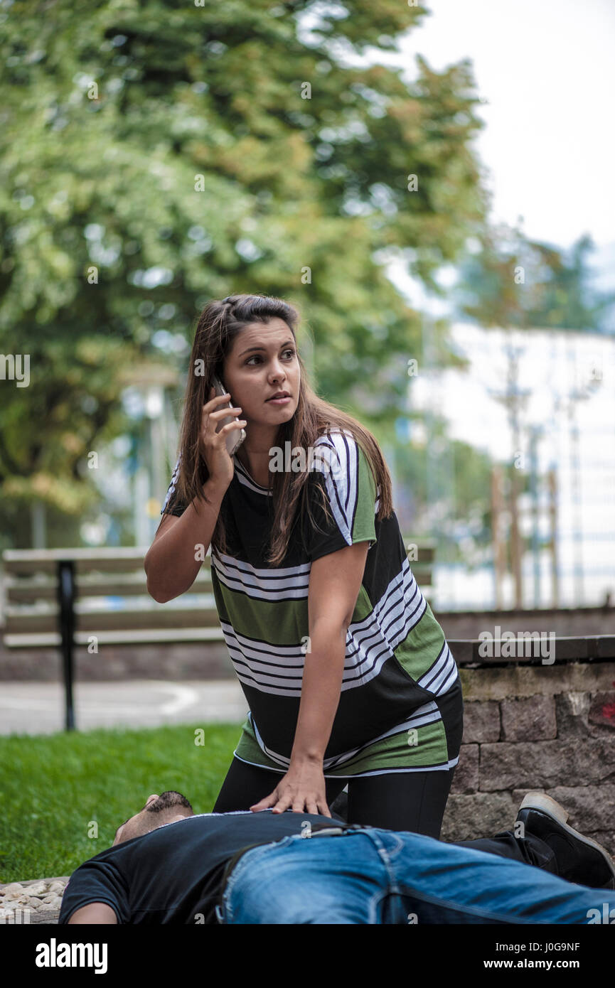 young girl helping a guy after heart attack with cardiopulmonary ...