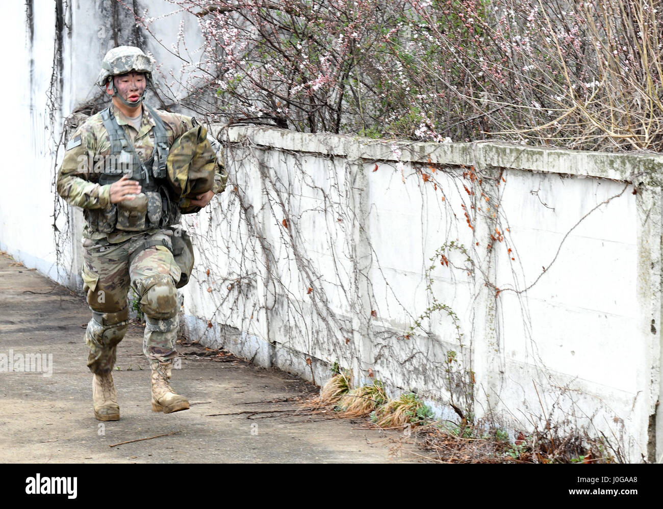 A medic from the 2nd Battalion, 1st Air Defense Artillery runs a combat ...