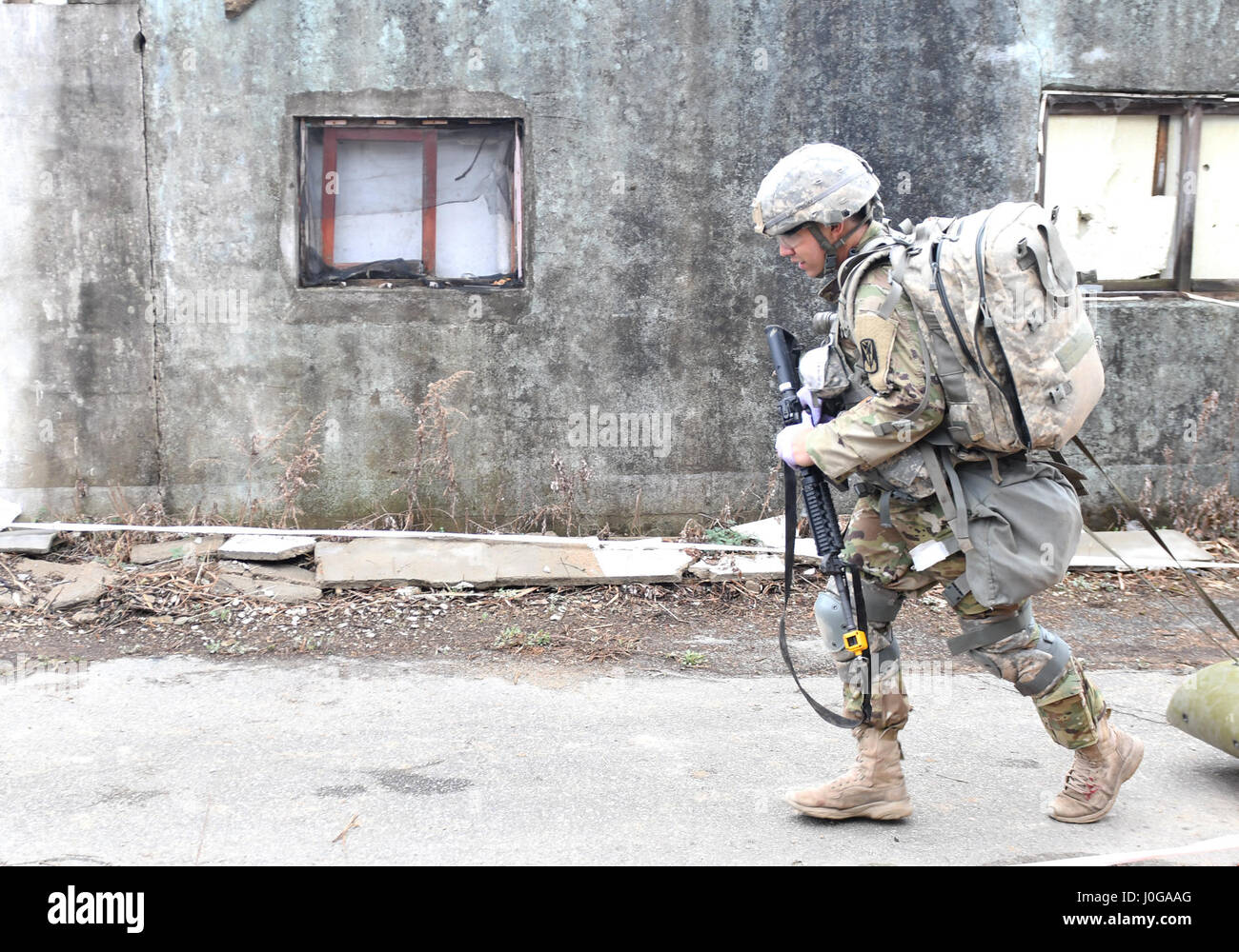 A U.S. Army medical NCO transports a simulated casualty down a combat ...