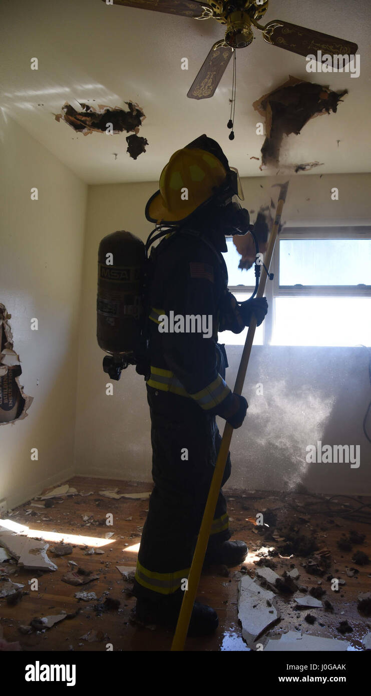A 22nd Civil Engineer Squadron firefighter performs overhaul and ...