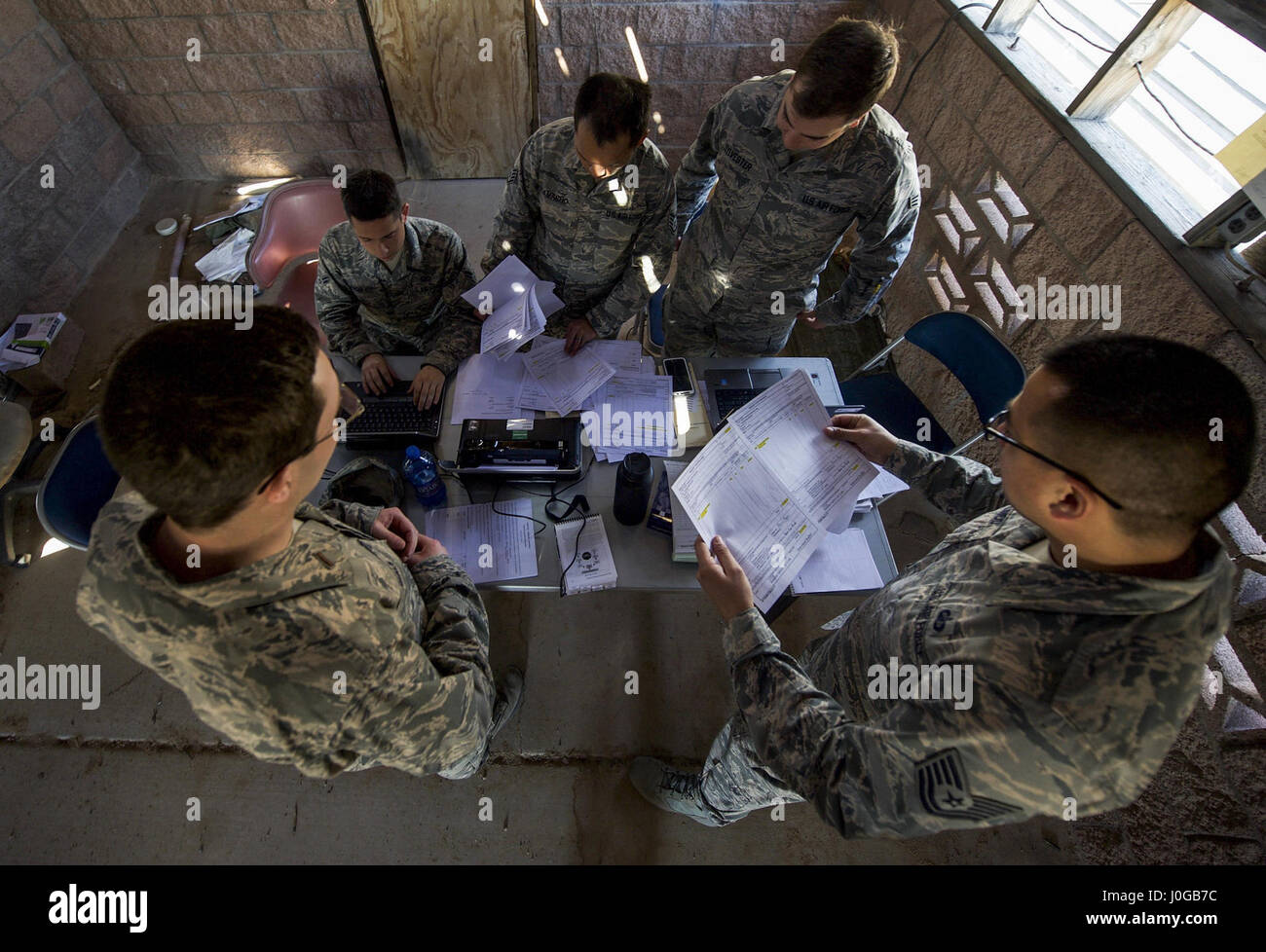 A team of U.S. Air Force contracting officers review offers after ...