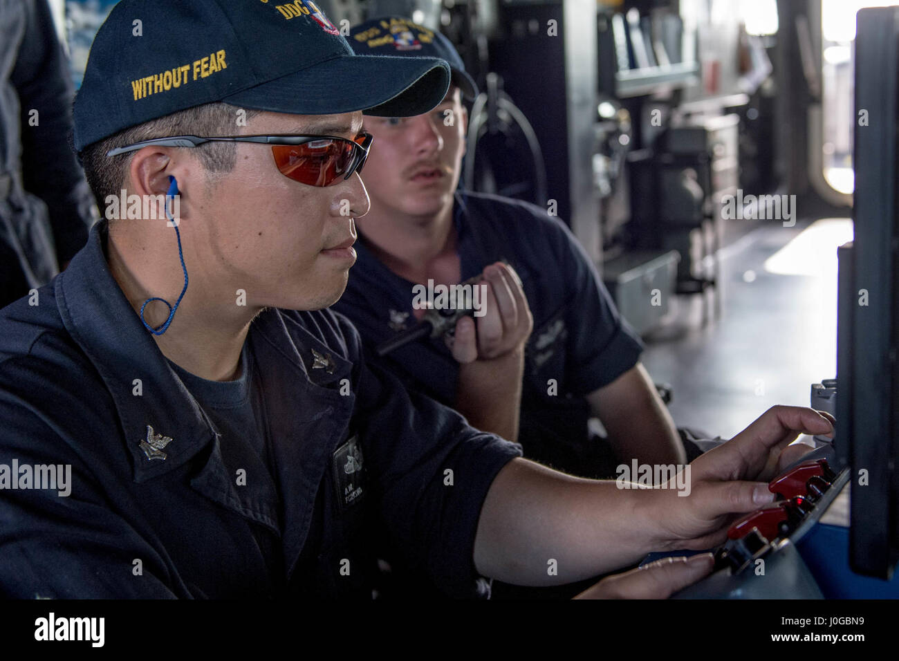 Fire Controlman operates a remote console to fire rounds during a live ...
