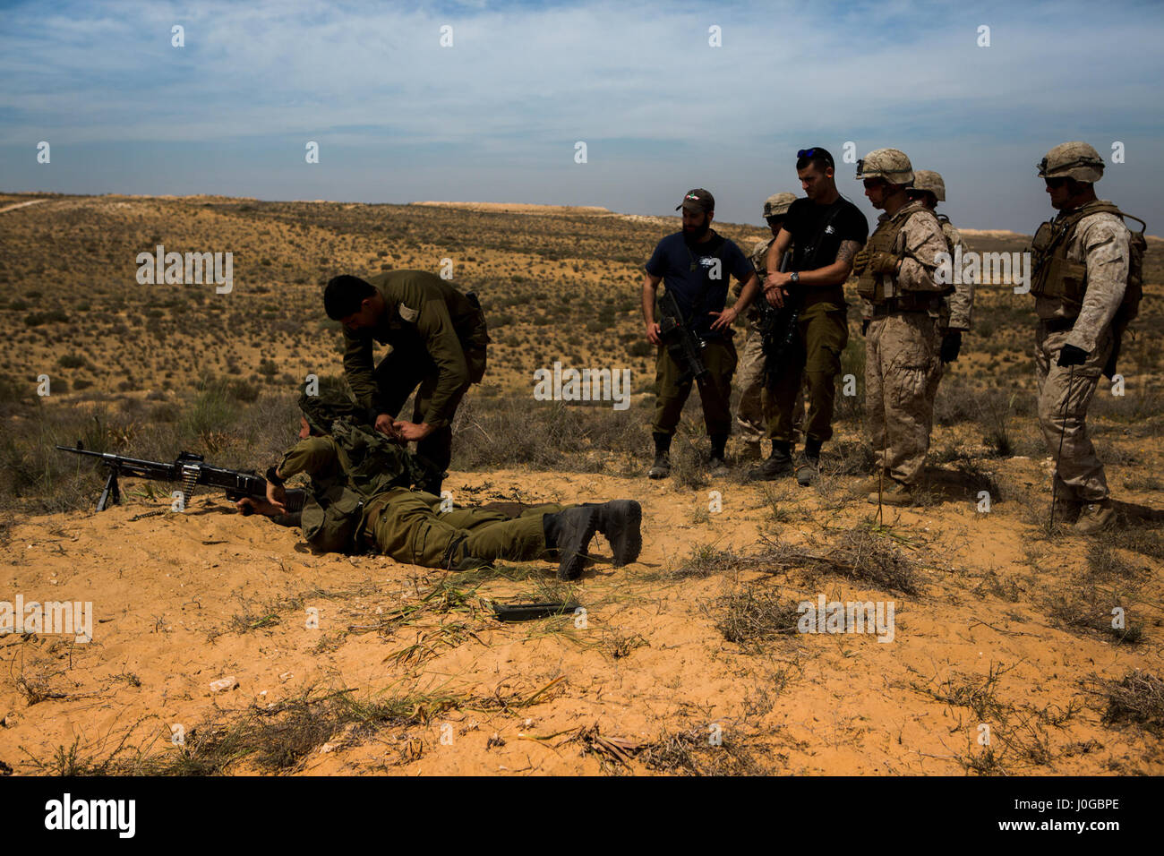 Israeli soldiers demonstrate their methods of employing machine guns to ...