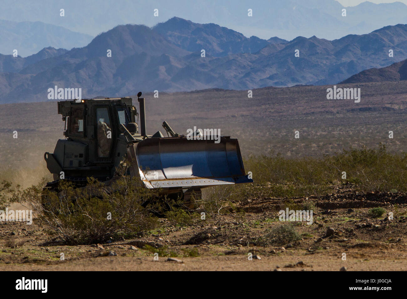 A dozer drives across a forward arming and refueling point during ...