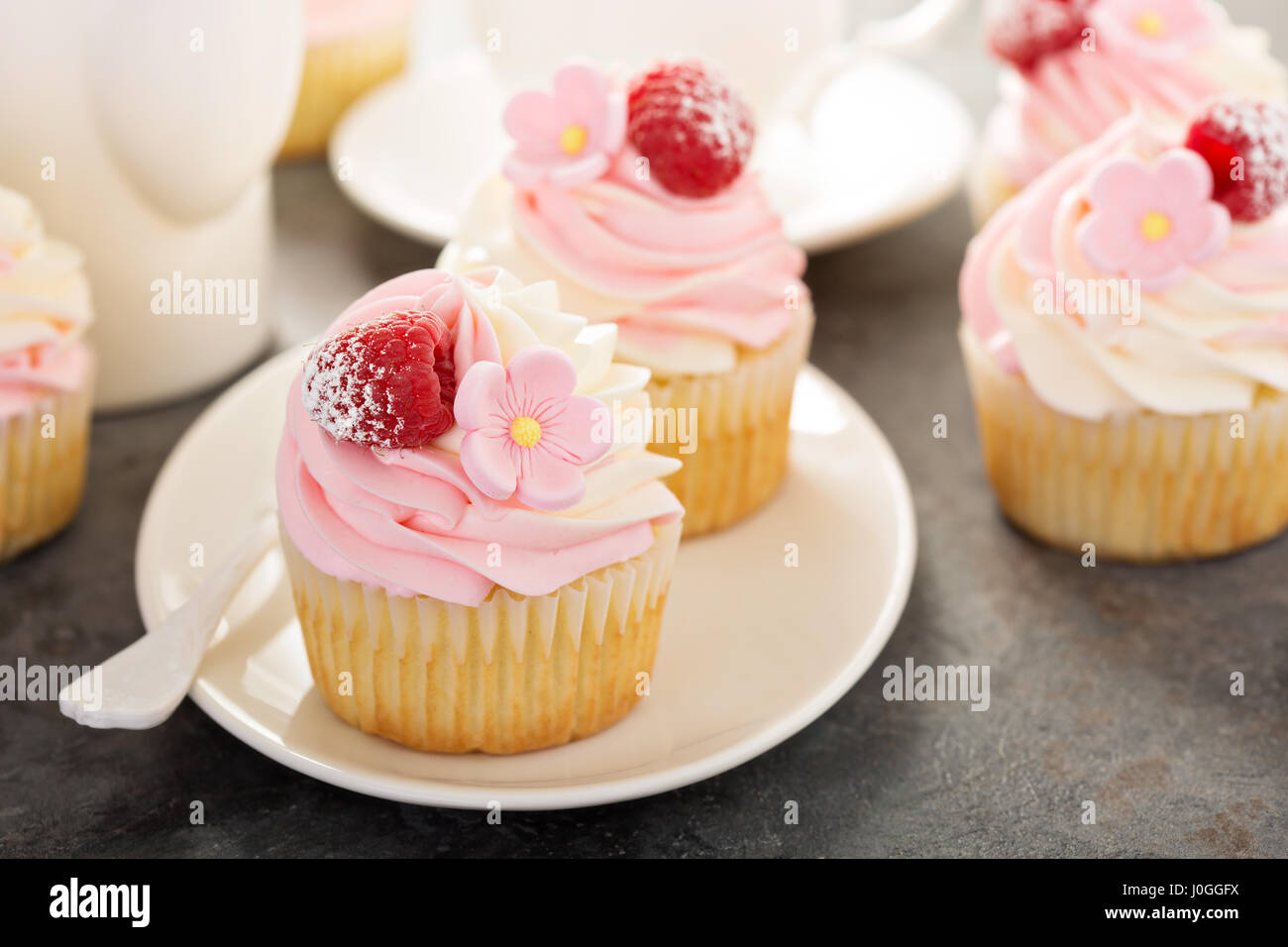 Pink vanilla and raspberry cupcakes Stock Photo - Alamy