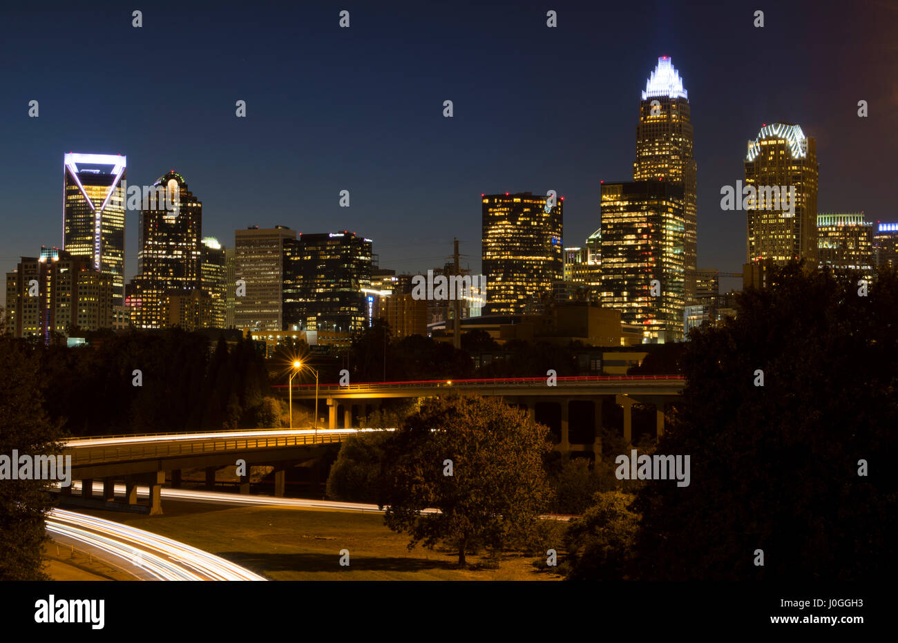 Charlotte North Carolina skyline at night with traffic blurs and ...