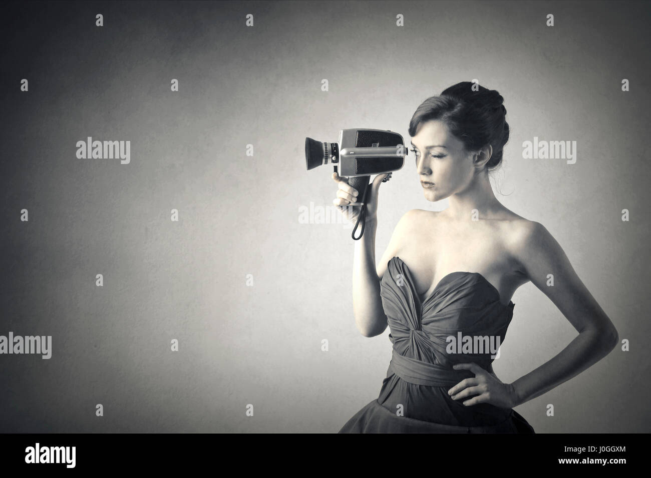 Elegant woman with video camera Stock Photo - Alamy