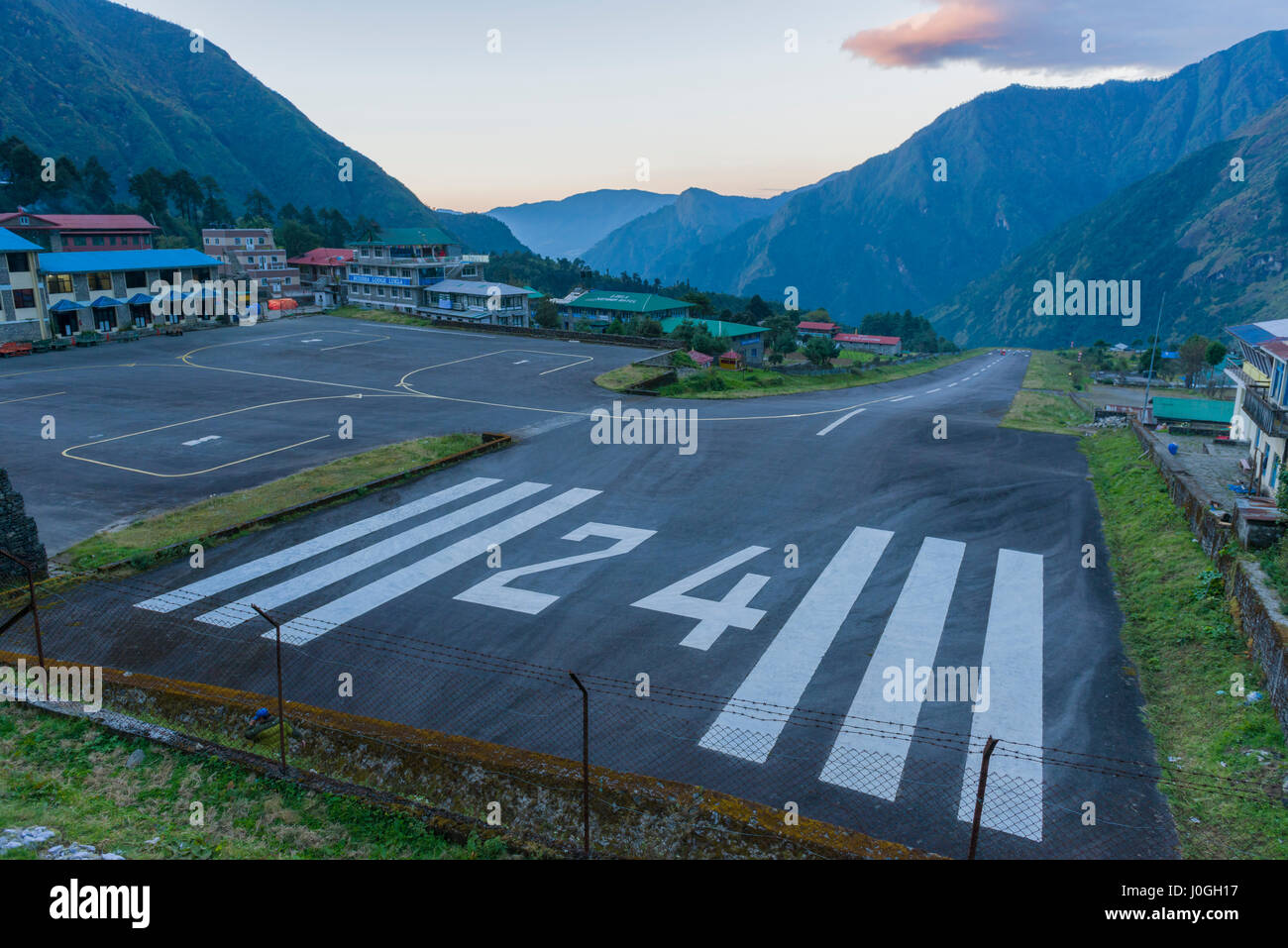 The sloped runway of Lukla Airport, Nepal, on a clear morning. Photo ...