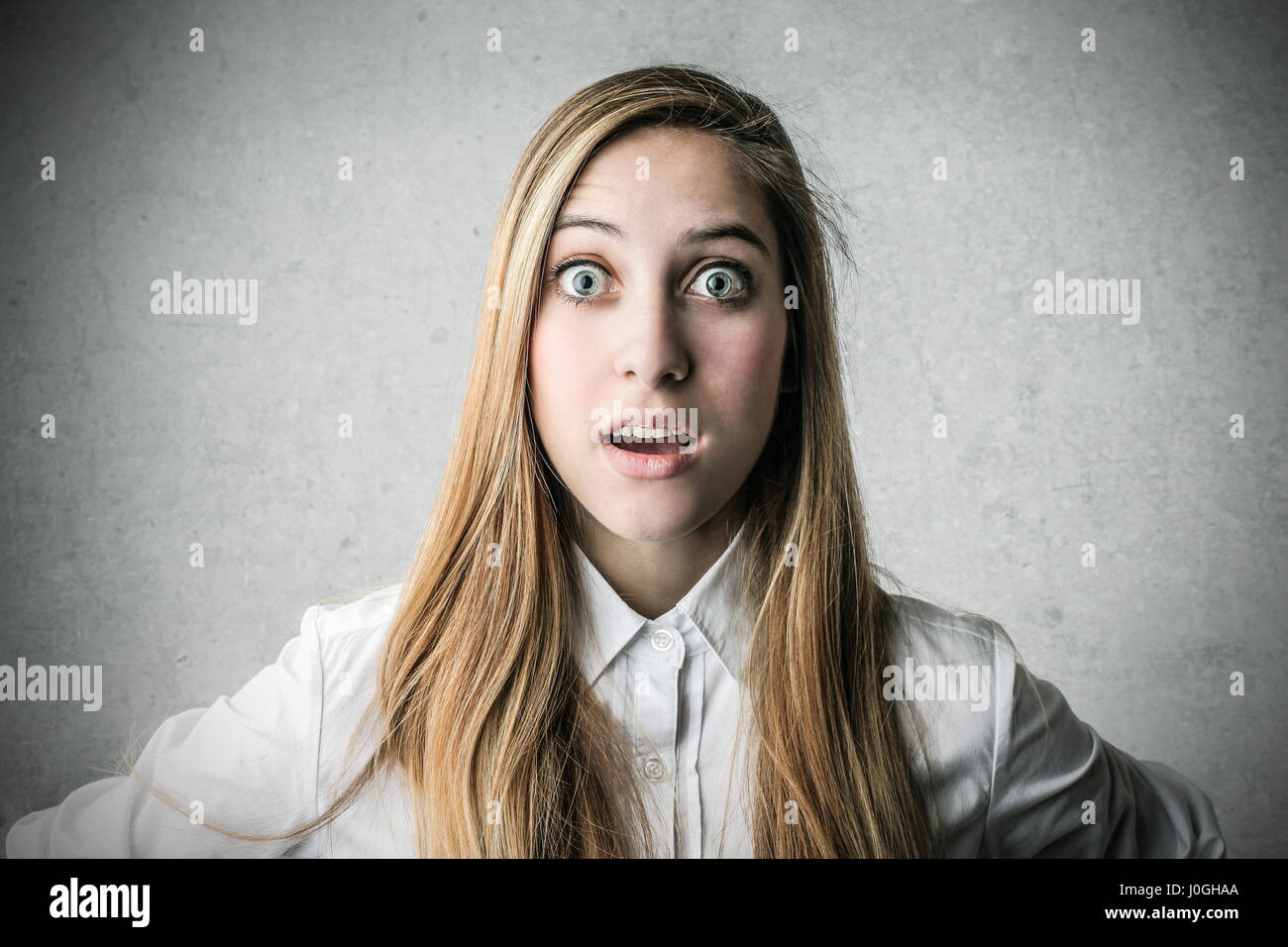 Blond woman being surprised Stock Photo - Alamy