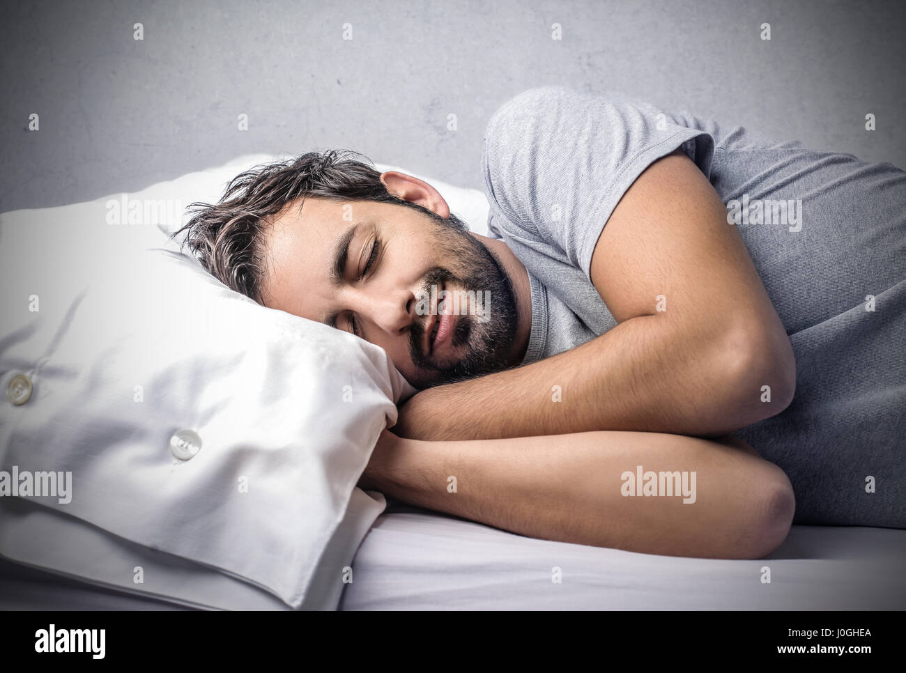 Man sleeping in bed Stock Photo - Alamy