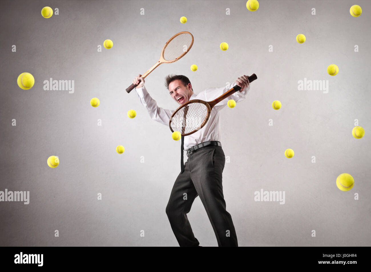 Man with rackets and tennis balls Stock Photo - Alamy