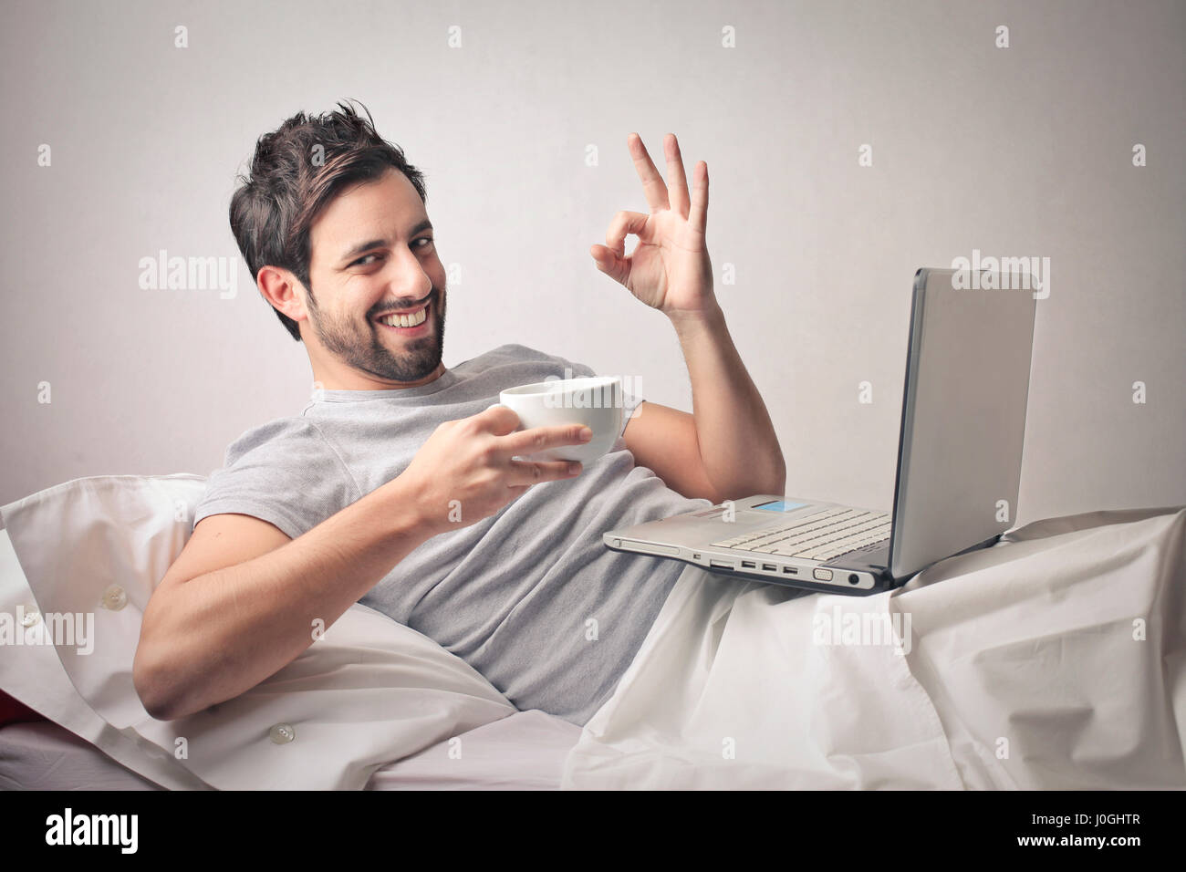 Man in bed being satisfied Stock Photo - Alamy