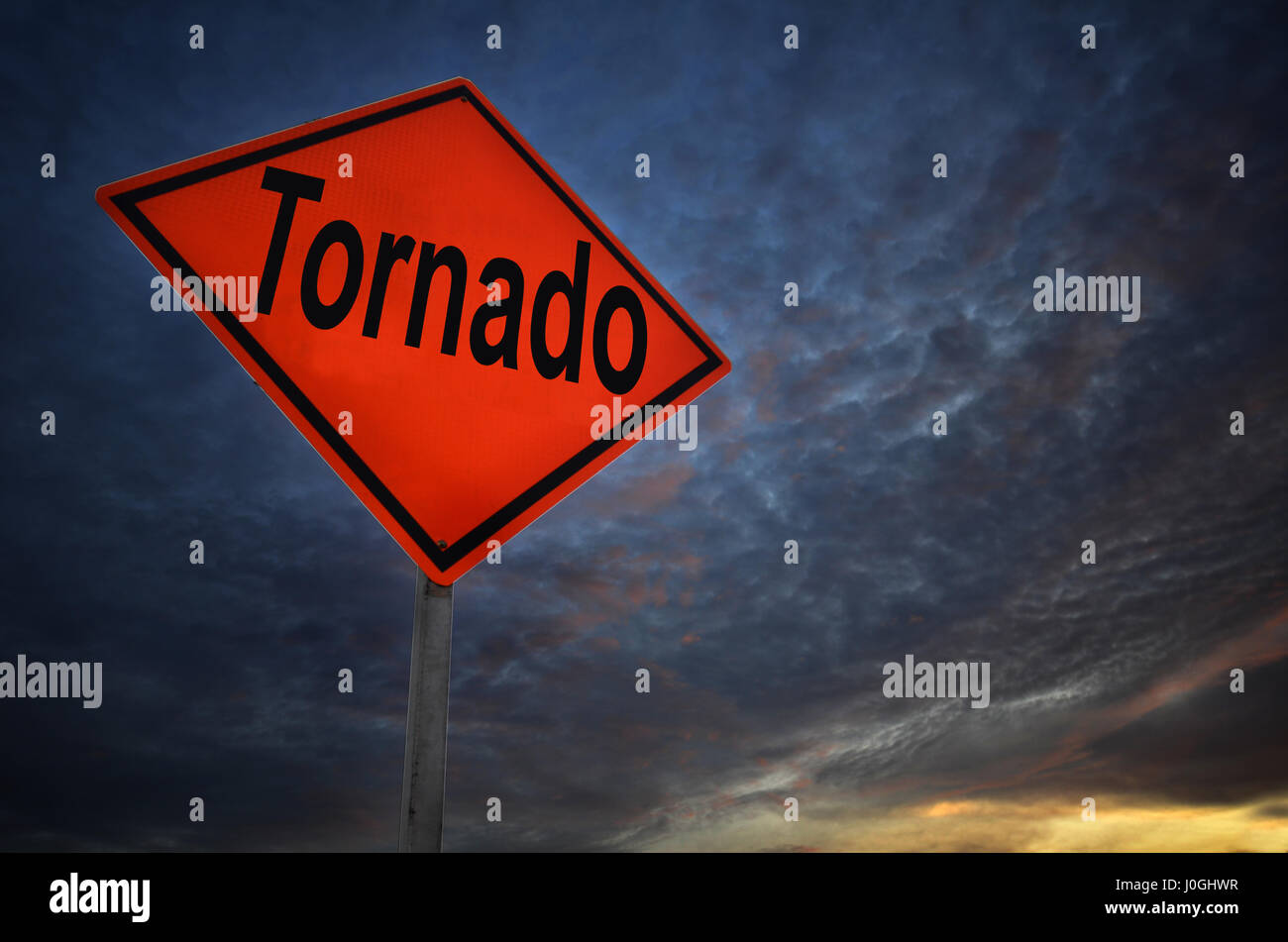 Orange storm road sign of tornado with dark cloud Stock Photo - Alamy