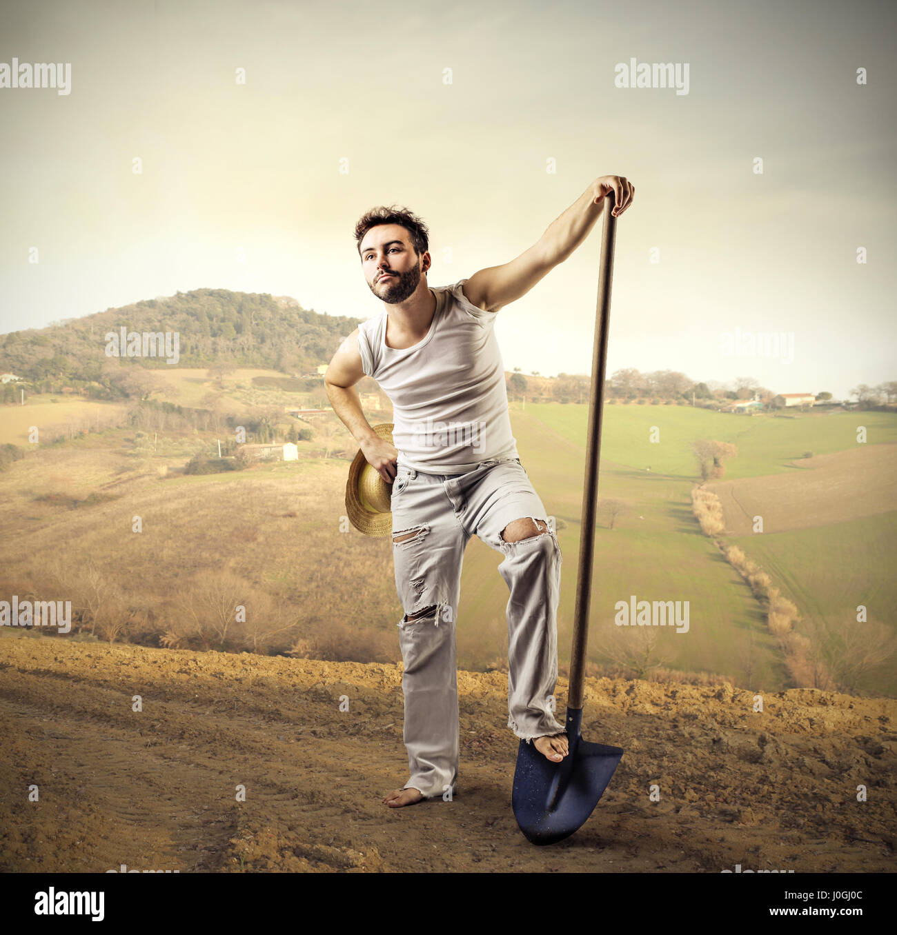 Man working with shovel Stock Photo - Alamy