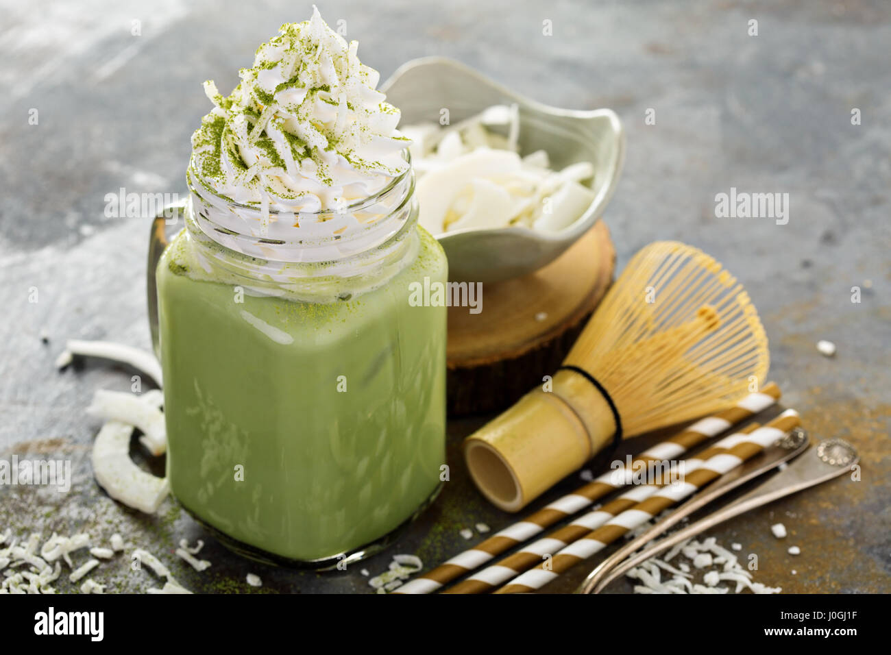 Iced matcha latte with coconut cream Stock Photo - Alamy