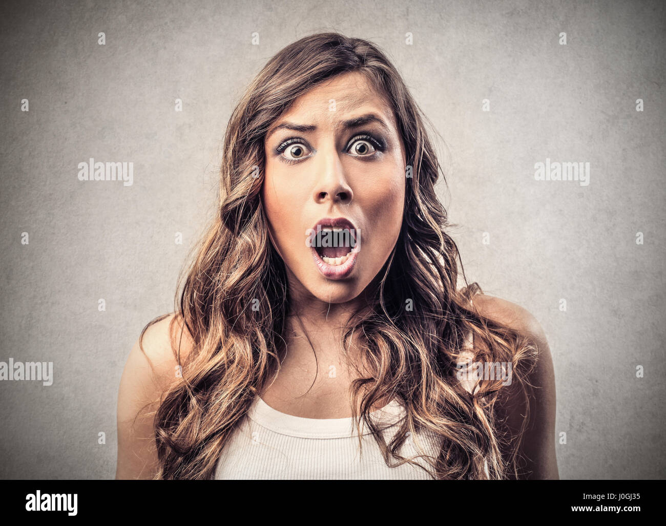 Brunette woman being scared Stock Photo - Alamy