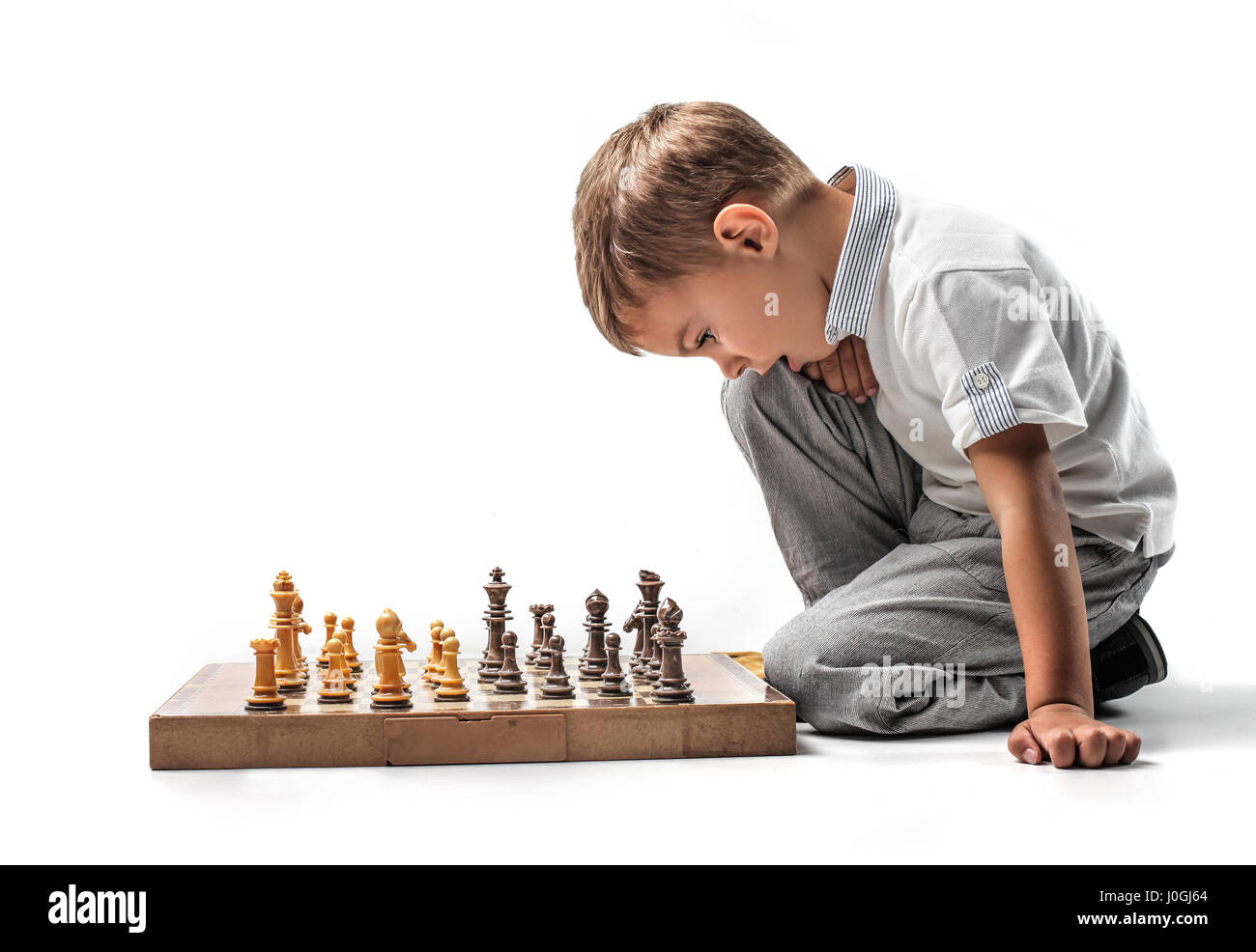 Little boy playing chess Stock Photo - Alamy