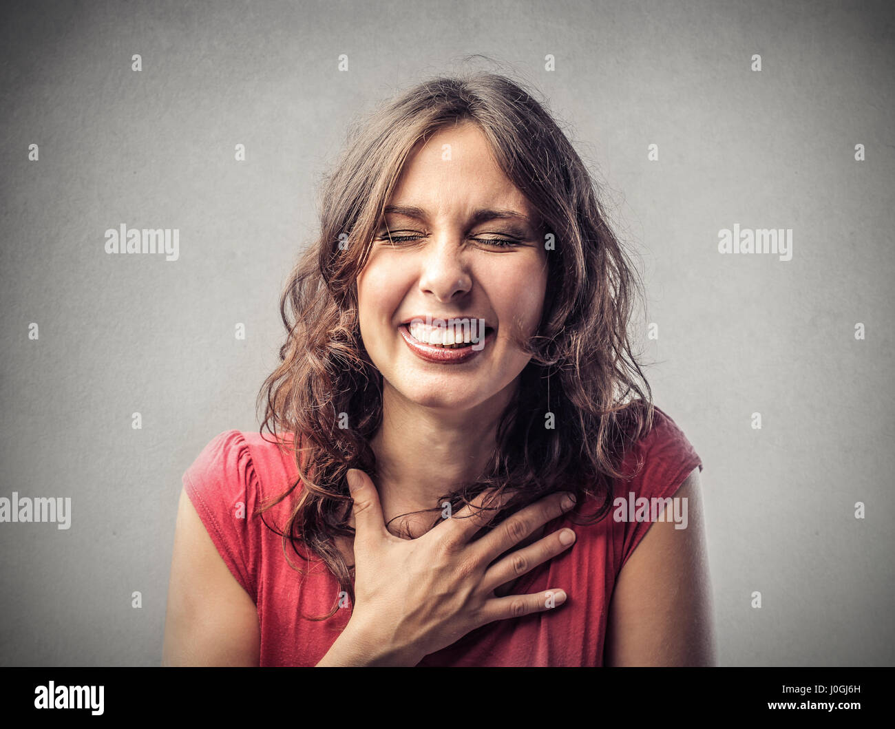 Brunette woman laughing inside Stock Photo - Alamy