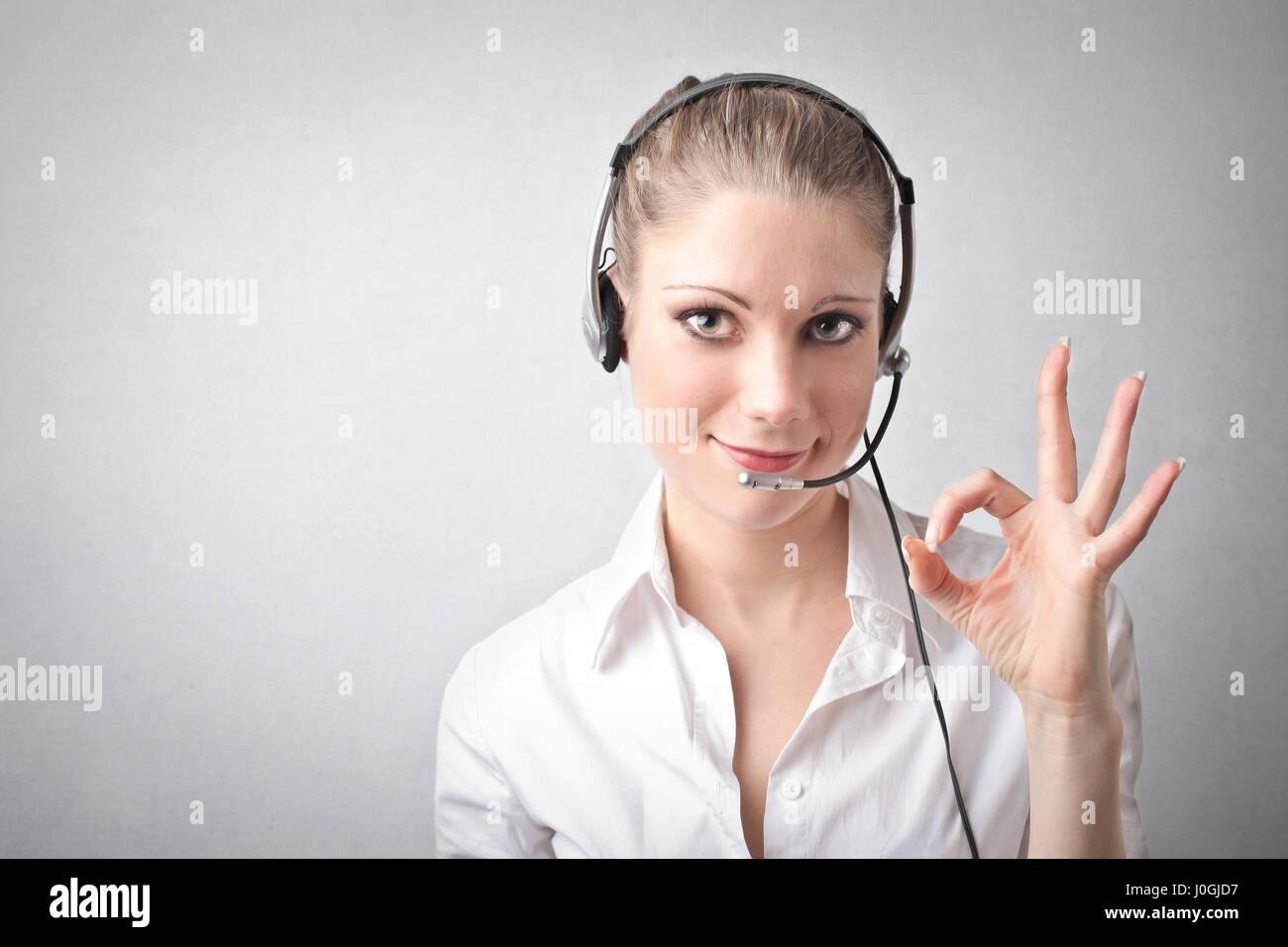 Blond businesswoman showing perfect sign Stock Photo - Alamy