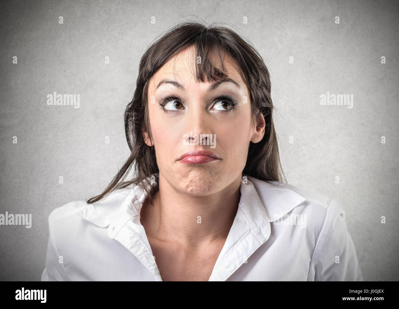 Woman feeling doubtful while thinking Stock Photo - Alamy