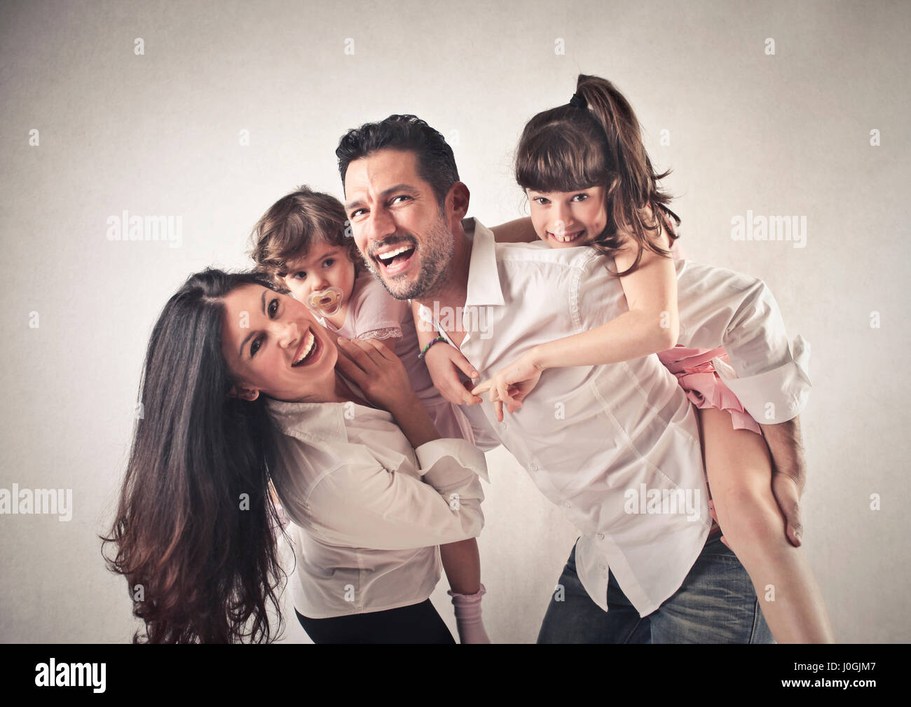 Family of 4 having fun together Stock Photo - Alamy