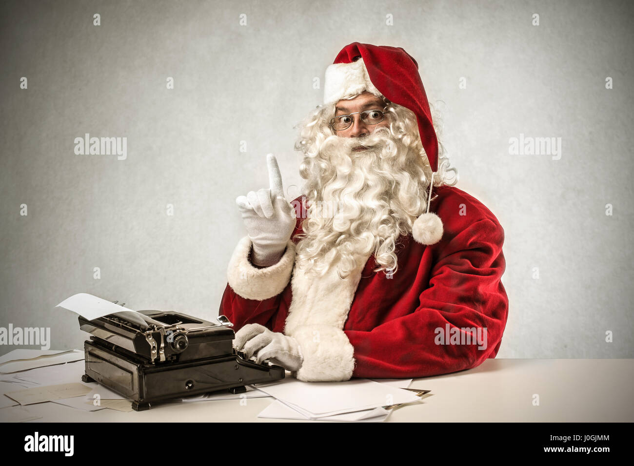 Santa Claus using typewriter Stock Photo - Alamy