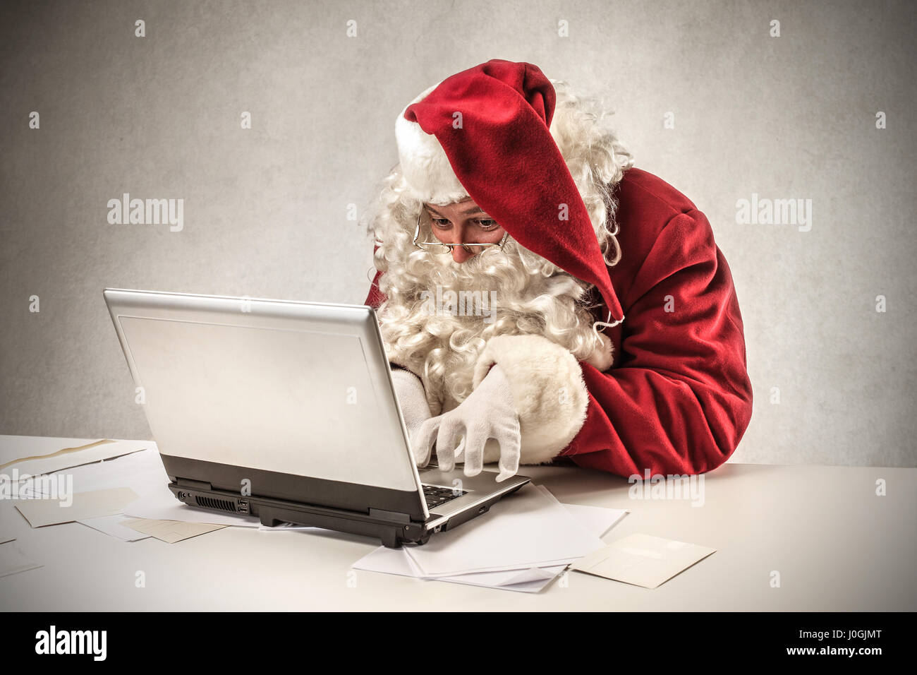 Santa Claus using laptop Stock Photo - Alamy