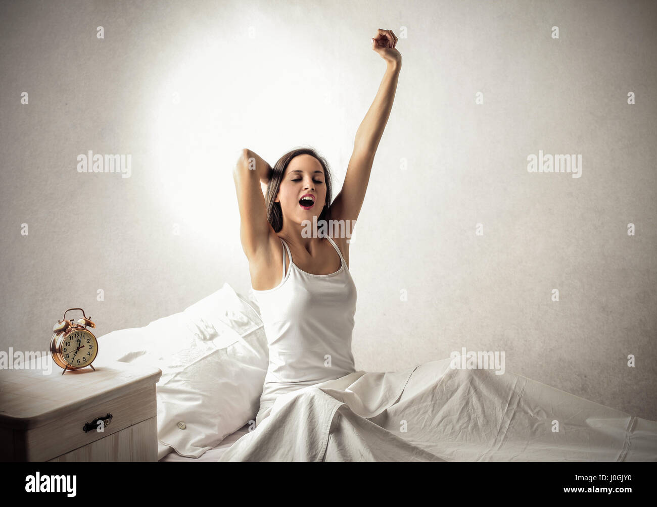 Woman waking up Stock Photo - Alamy