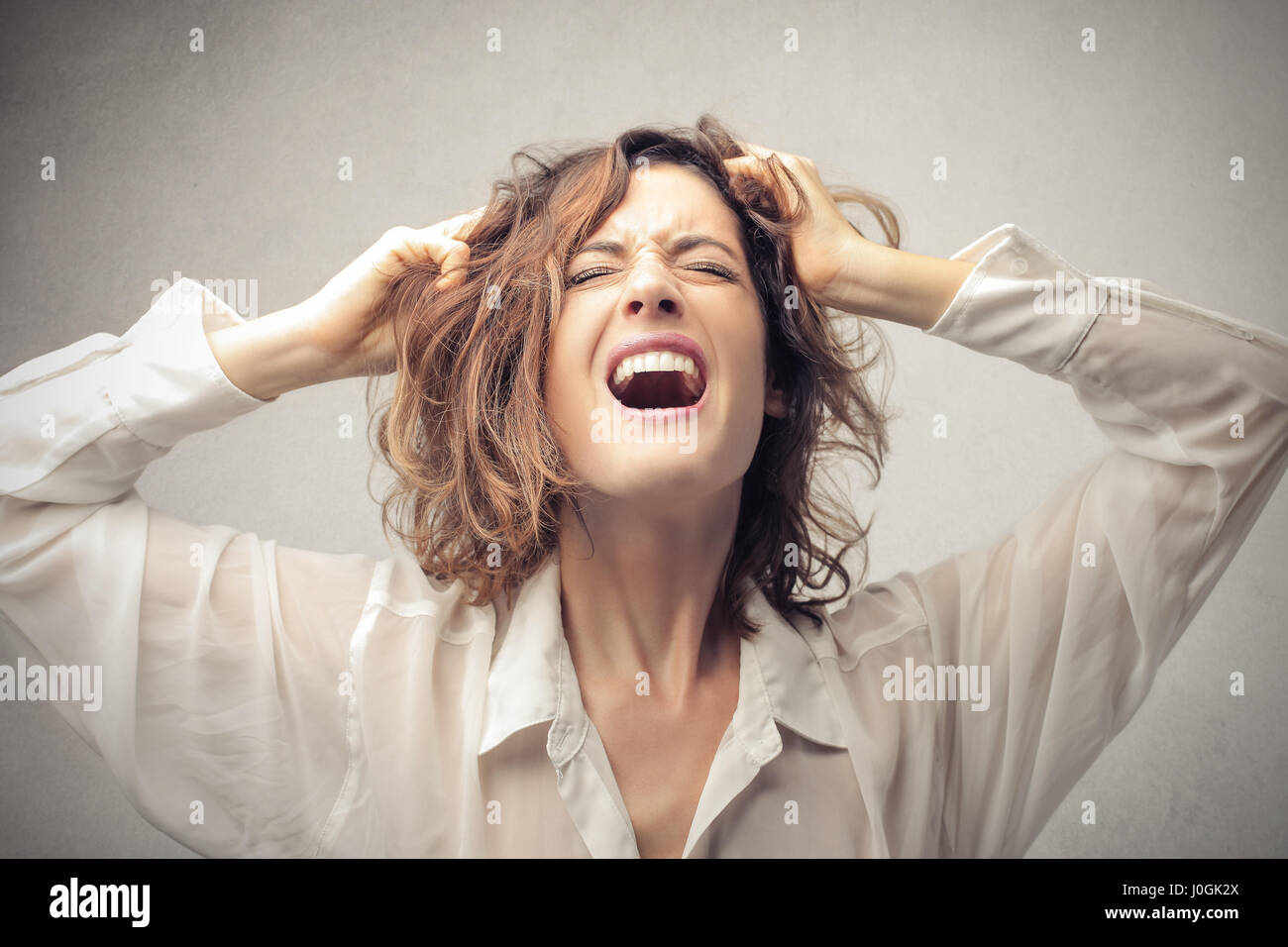 Brunette woman being stressed Stock Photo - Alamy