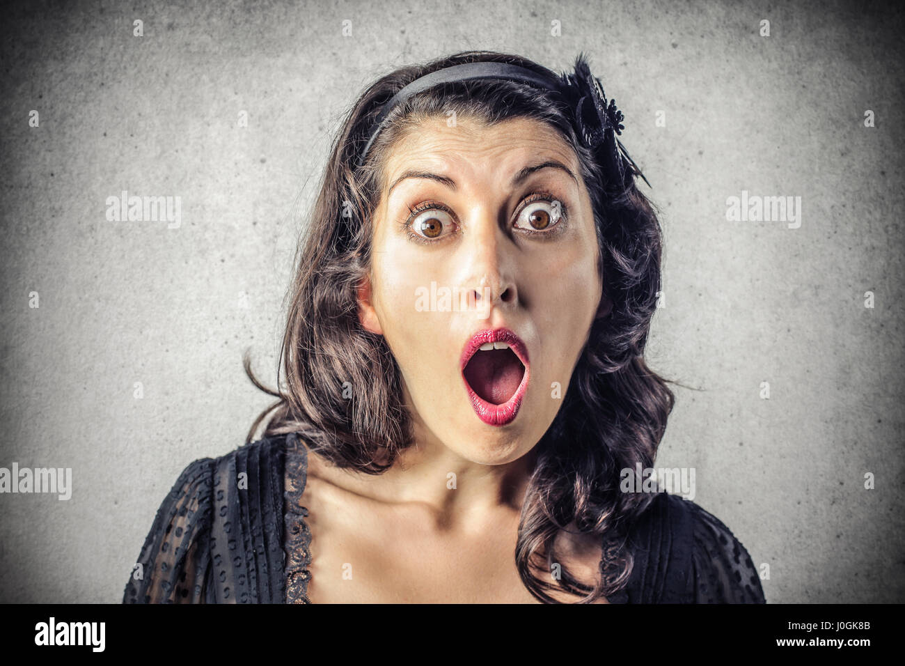 Brunette woman being surprised Stock Photo - Alamy