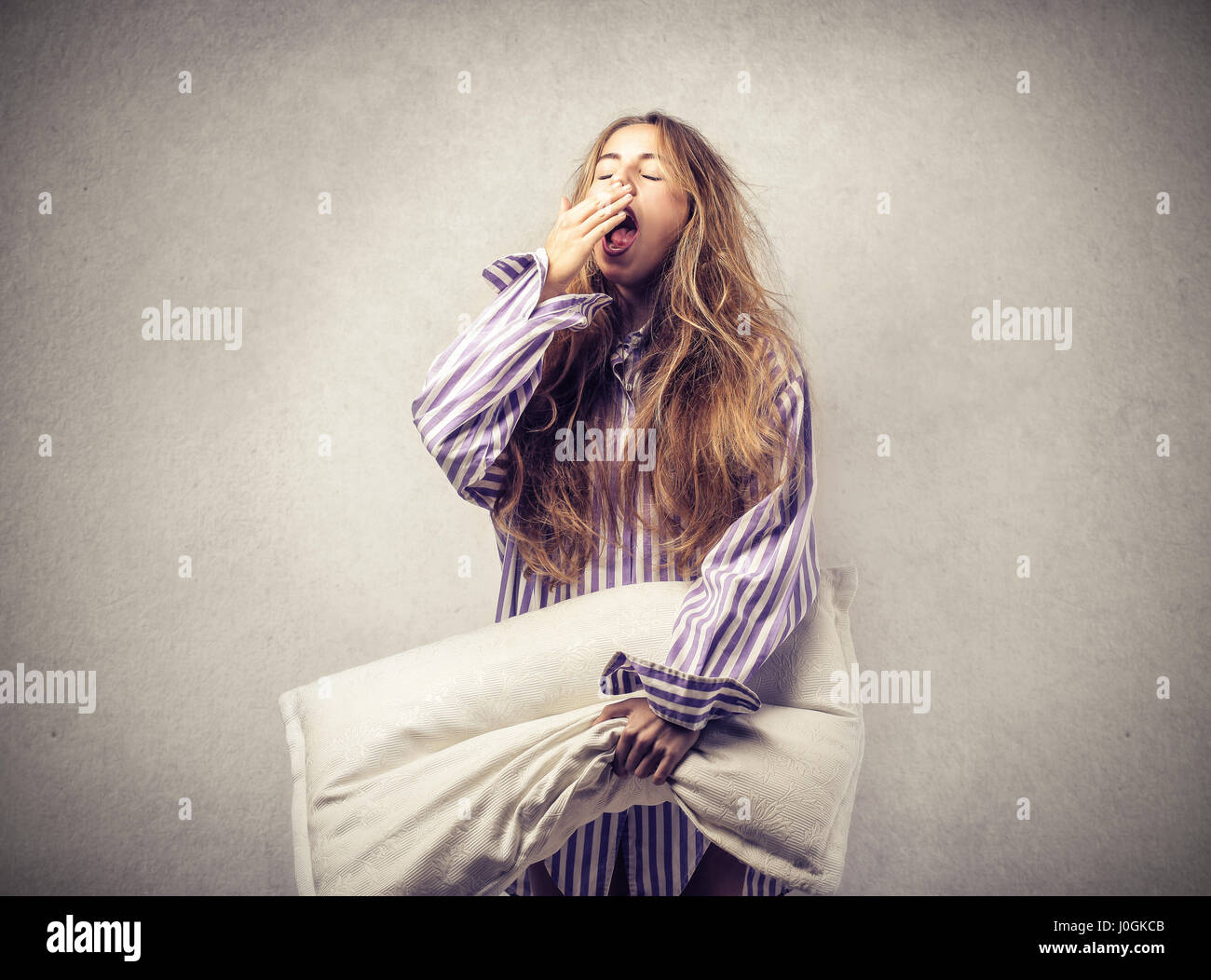 Sleepy woman with pillow Stock Photo - Alamy