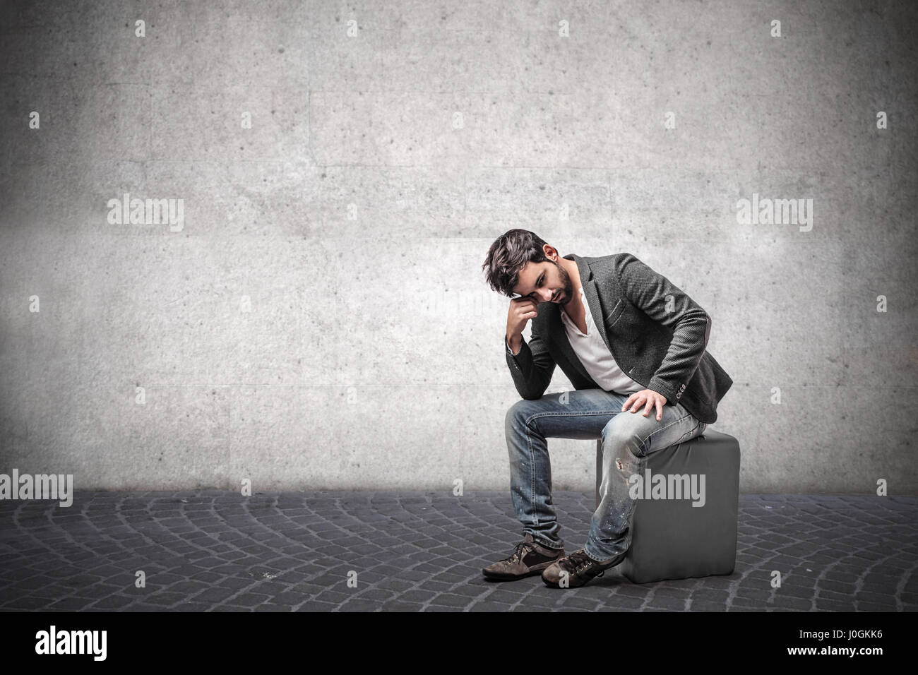 Man thinking while sitting Stock Photo - Alamy