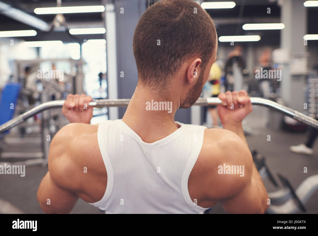 Man doing bicep parts on the gym Stock Photo - Alamy