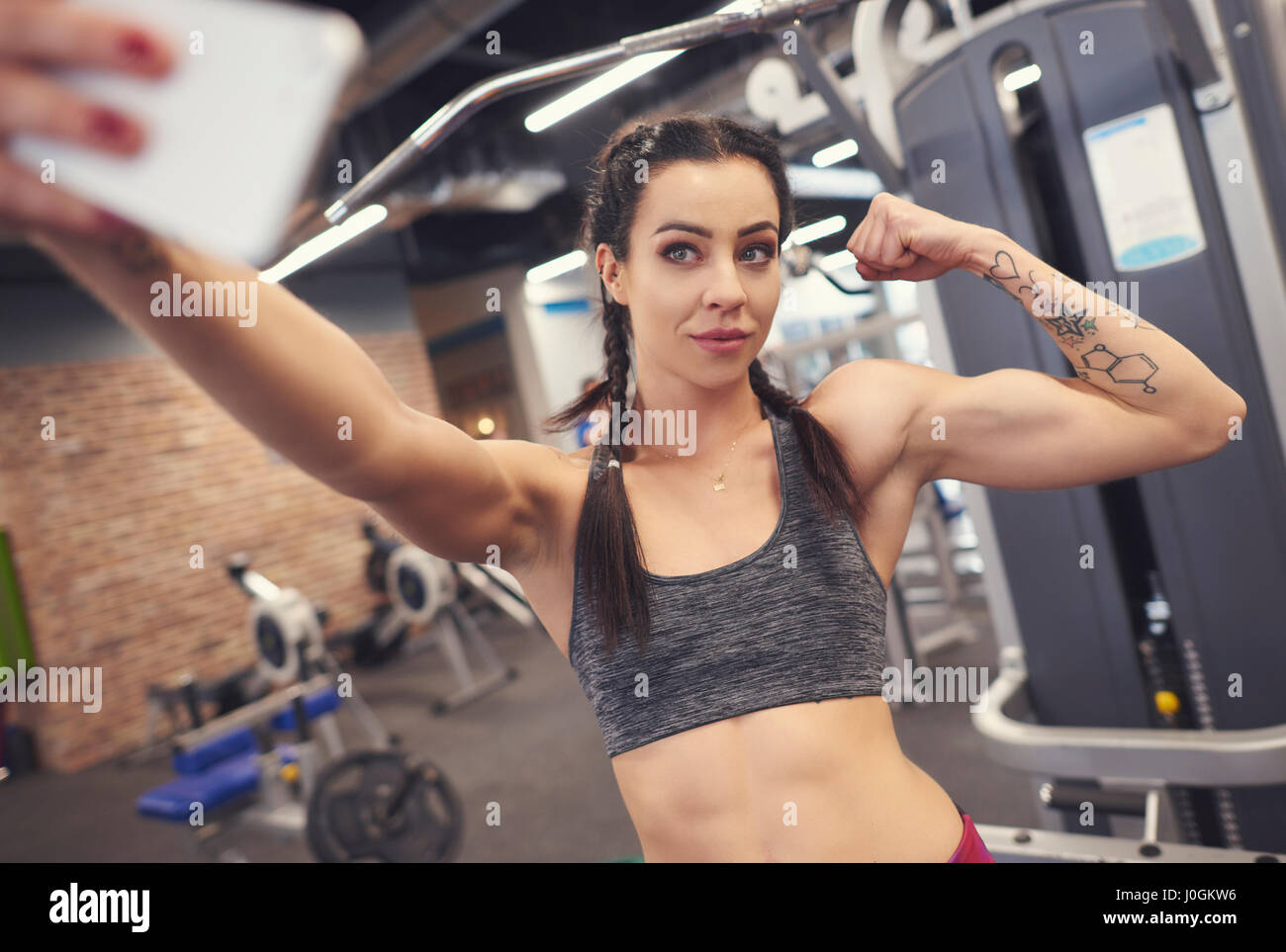 Female athlete taking selfie at gym Stock Photo - Alamy