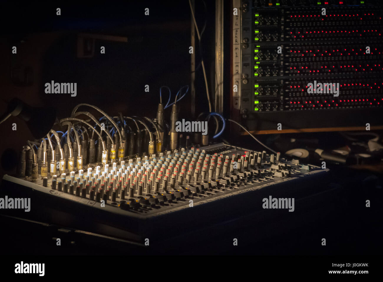 spotlight illuminating a soundboard mixer at a live music event Stock ...