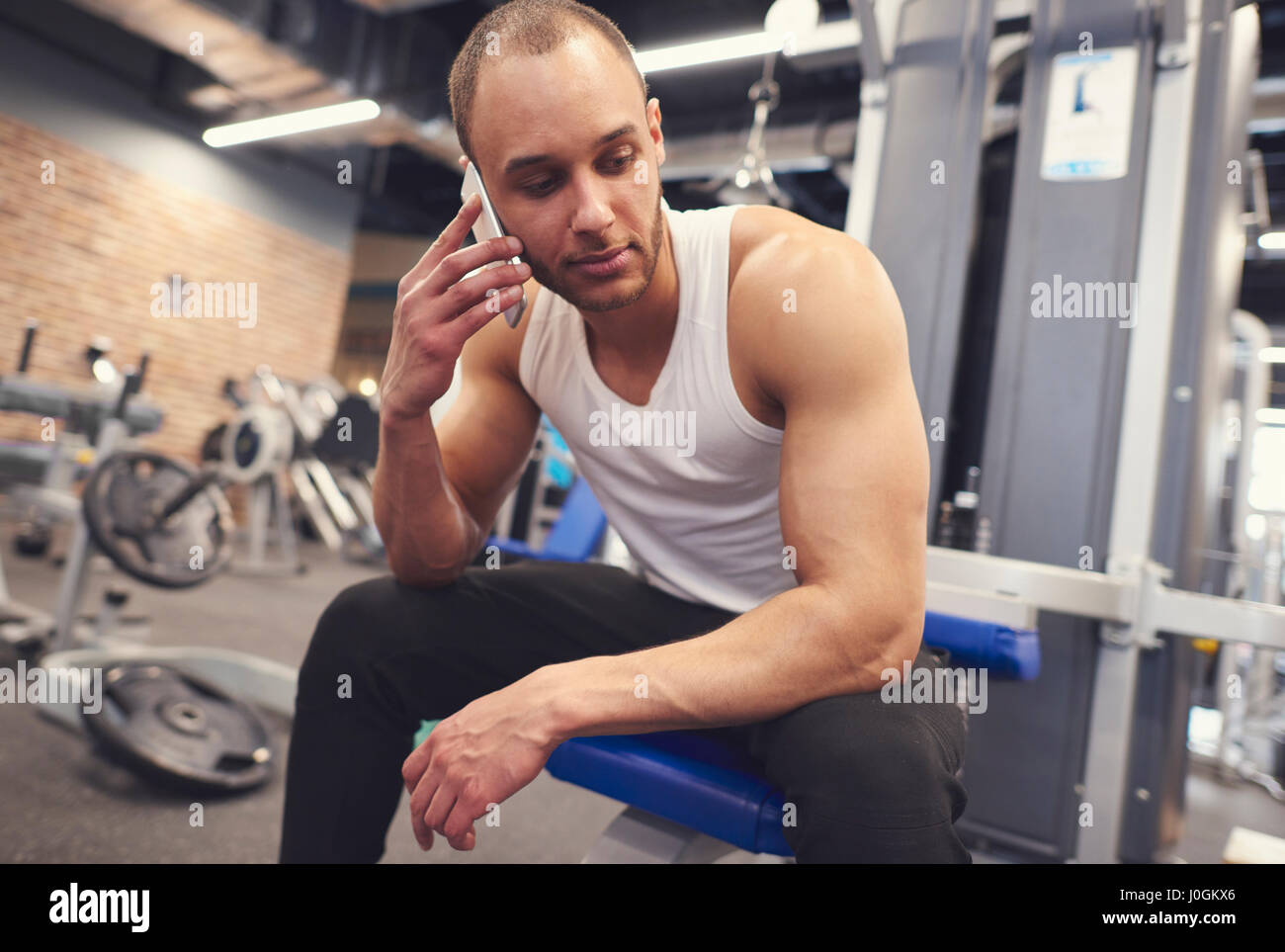 Male athlete having a call over training Stock Photo - Alamy